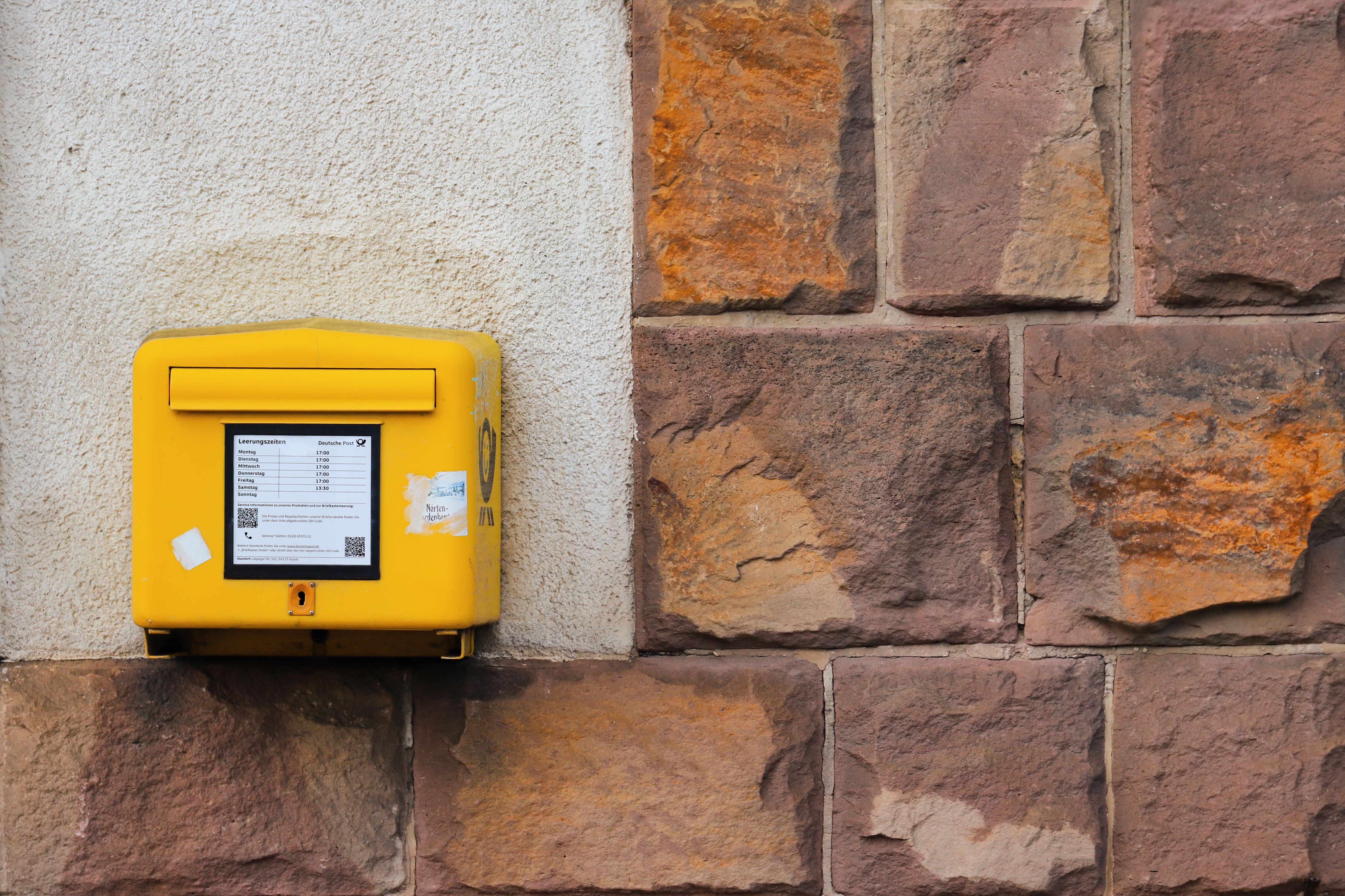 Yellow Mailbox on Rustic Stone Wall in Germany · Free Stock Photo
