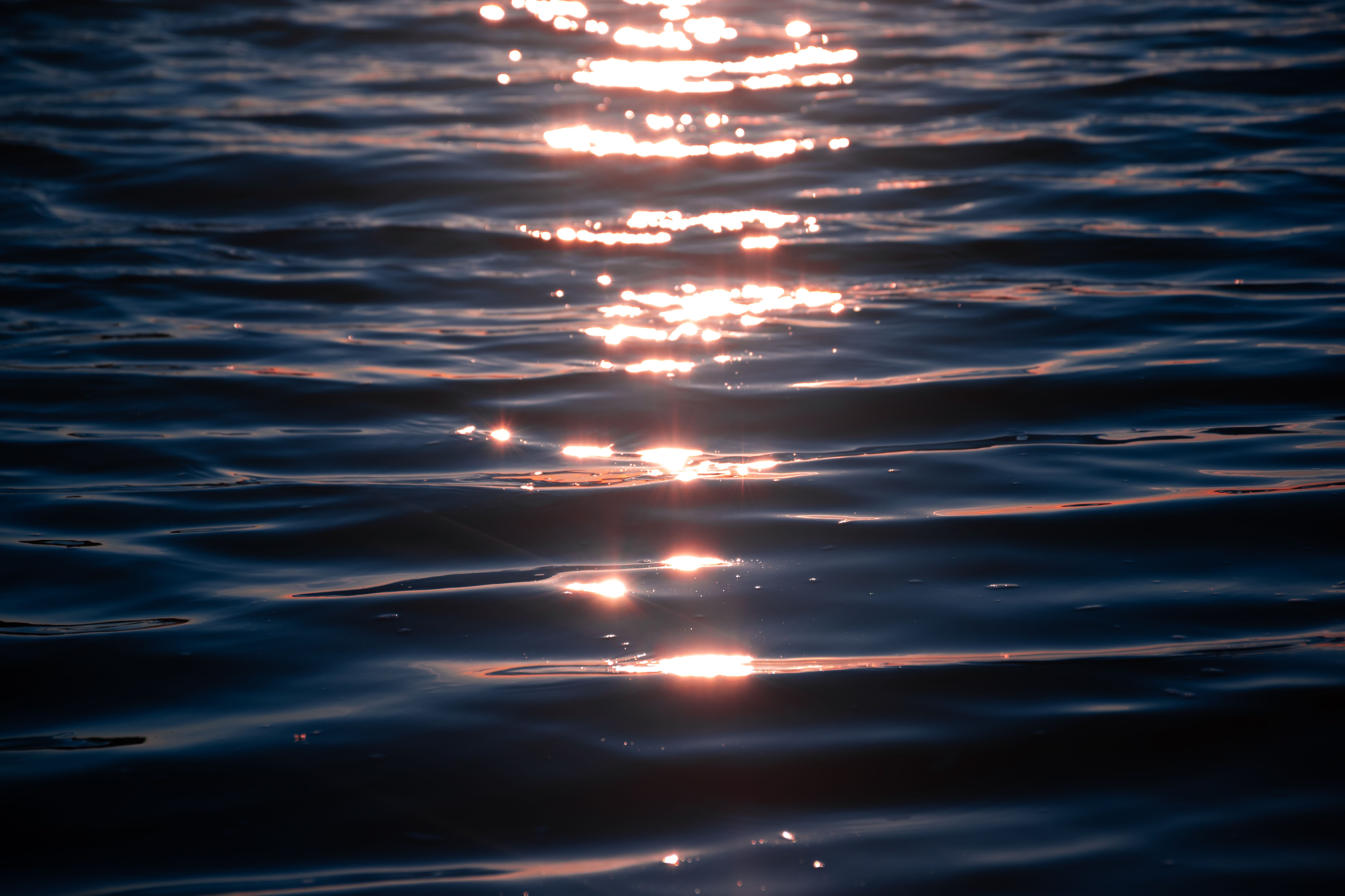 Sparkling Sunset Reflection on Ocean Waves · Free Stock Photo