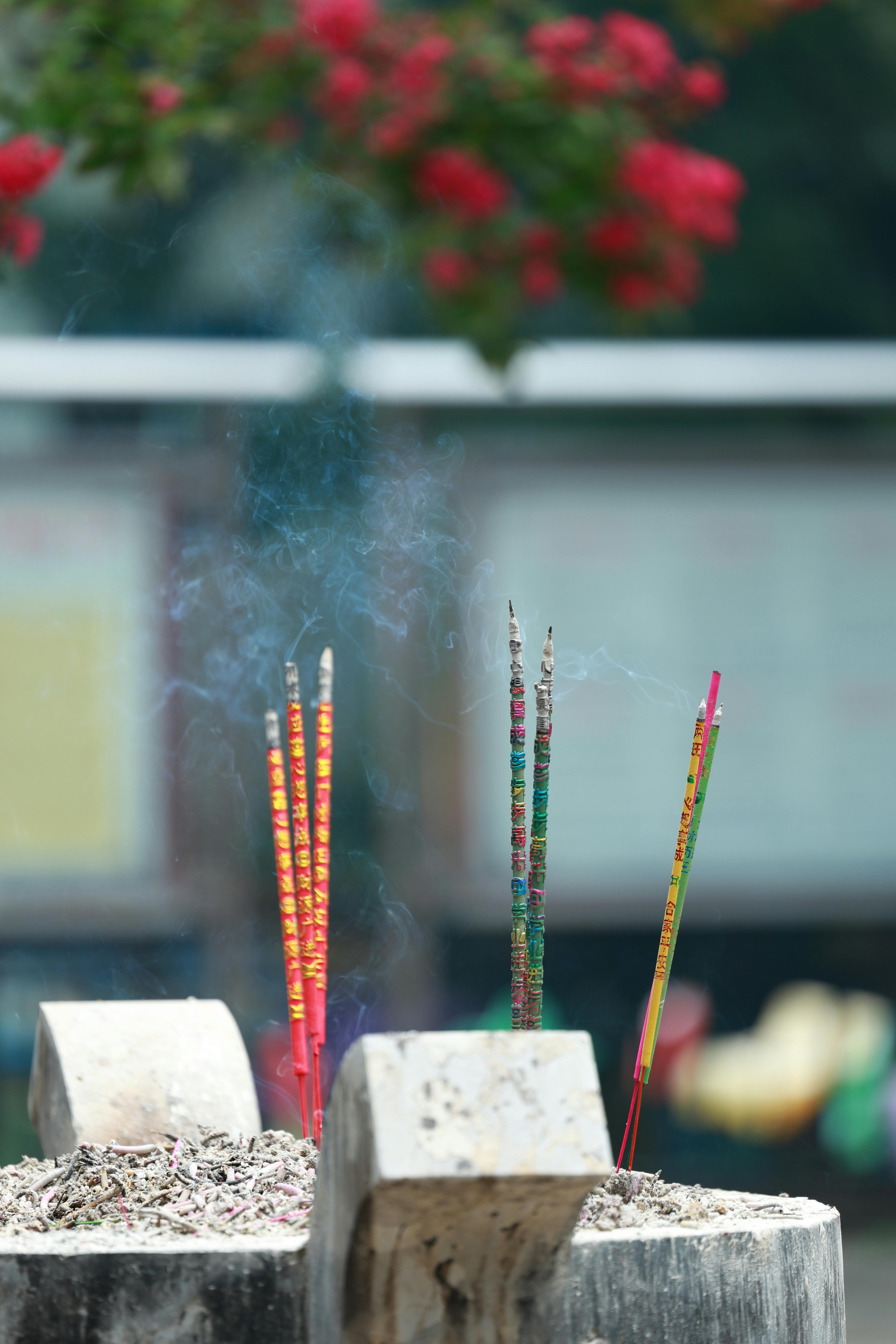 Colorful Incense Sticks in Outdoor Setting · Free Stock Photo