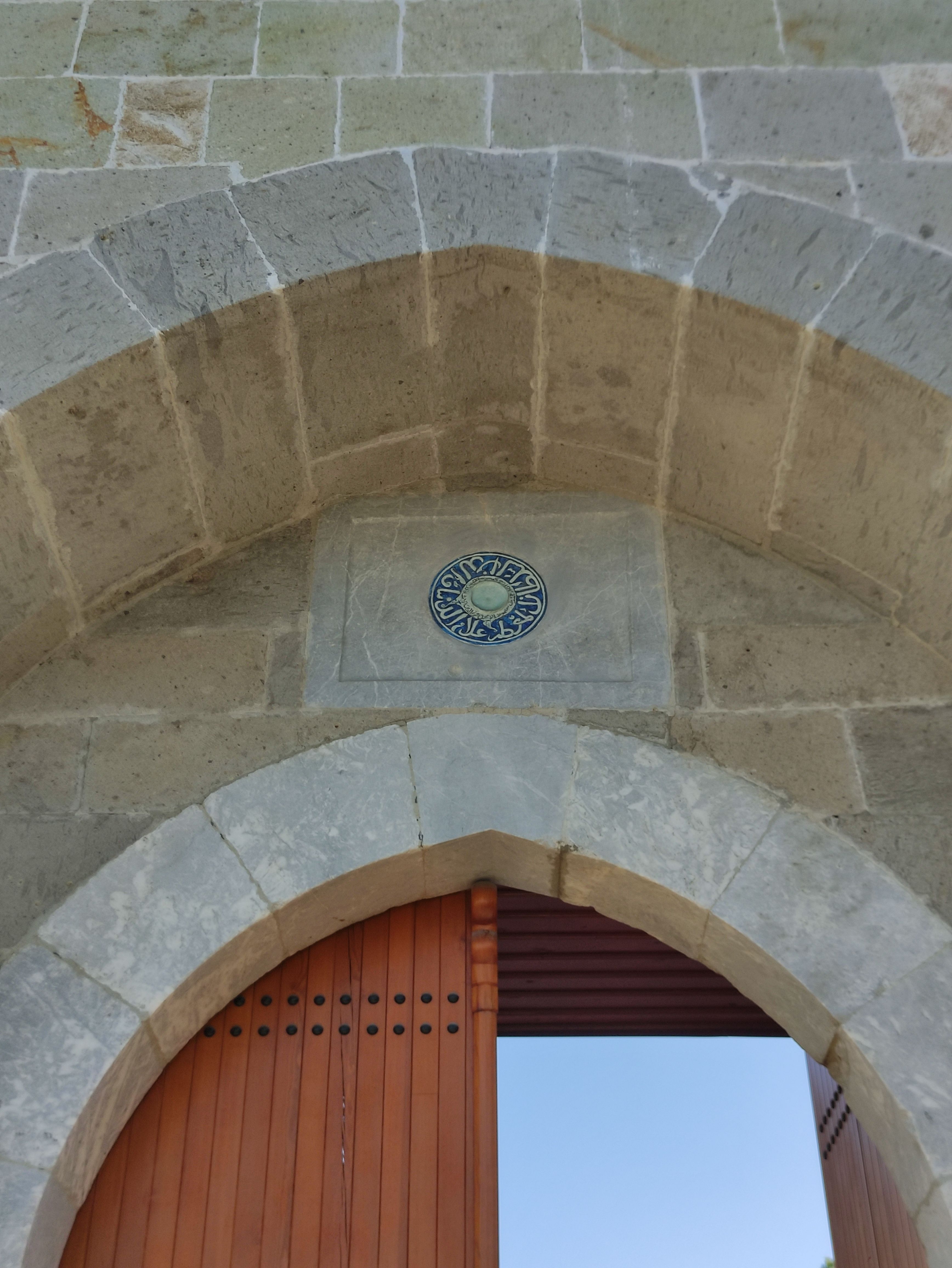 Ancient Stone Archway with Intricate Inscription · Free Stock Photo