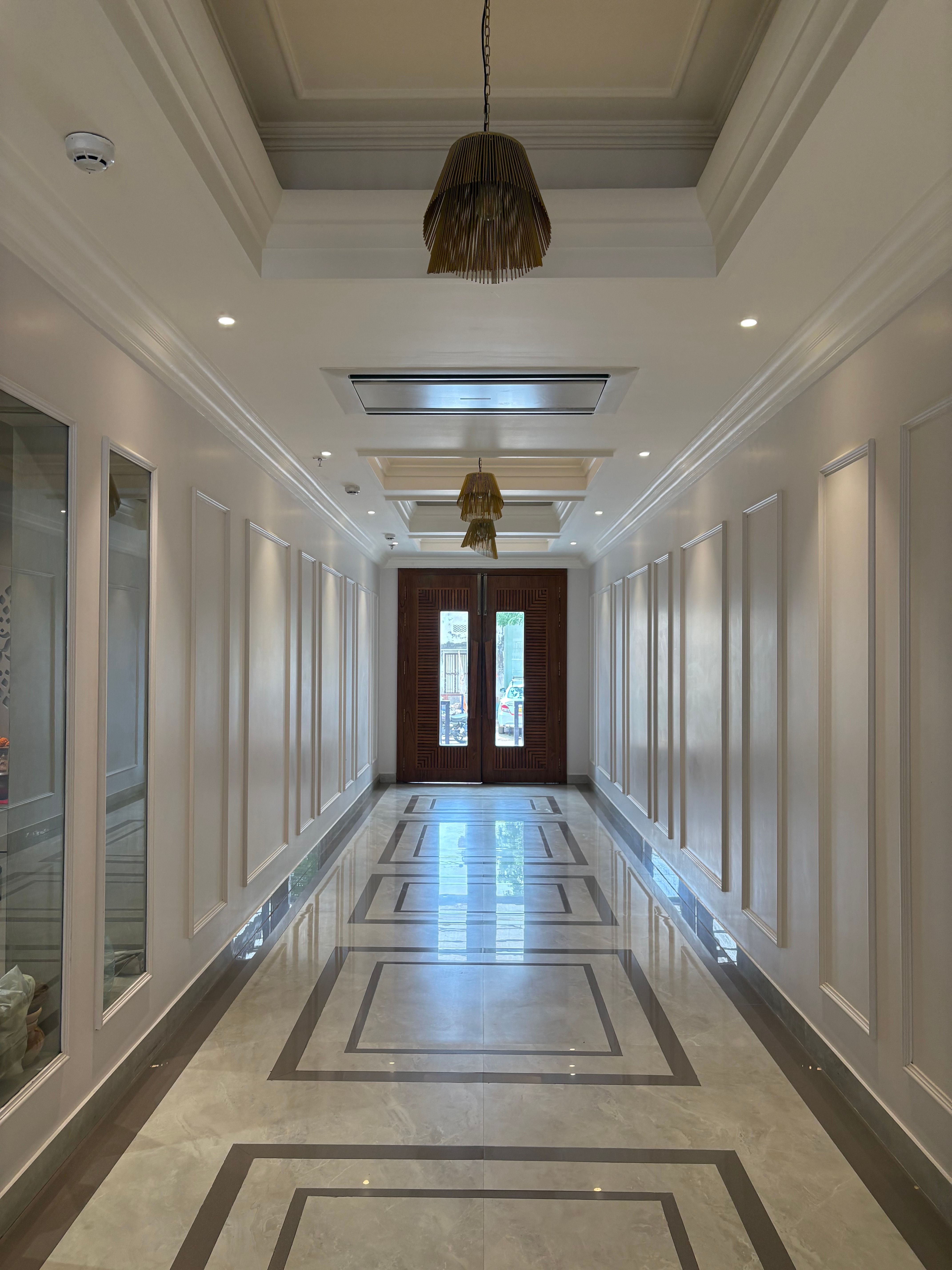 Elegant Modern Hallway with Geometric Floor Design · Free Stock Photo