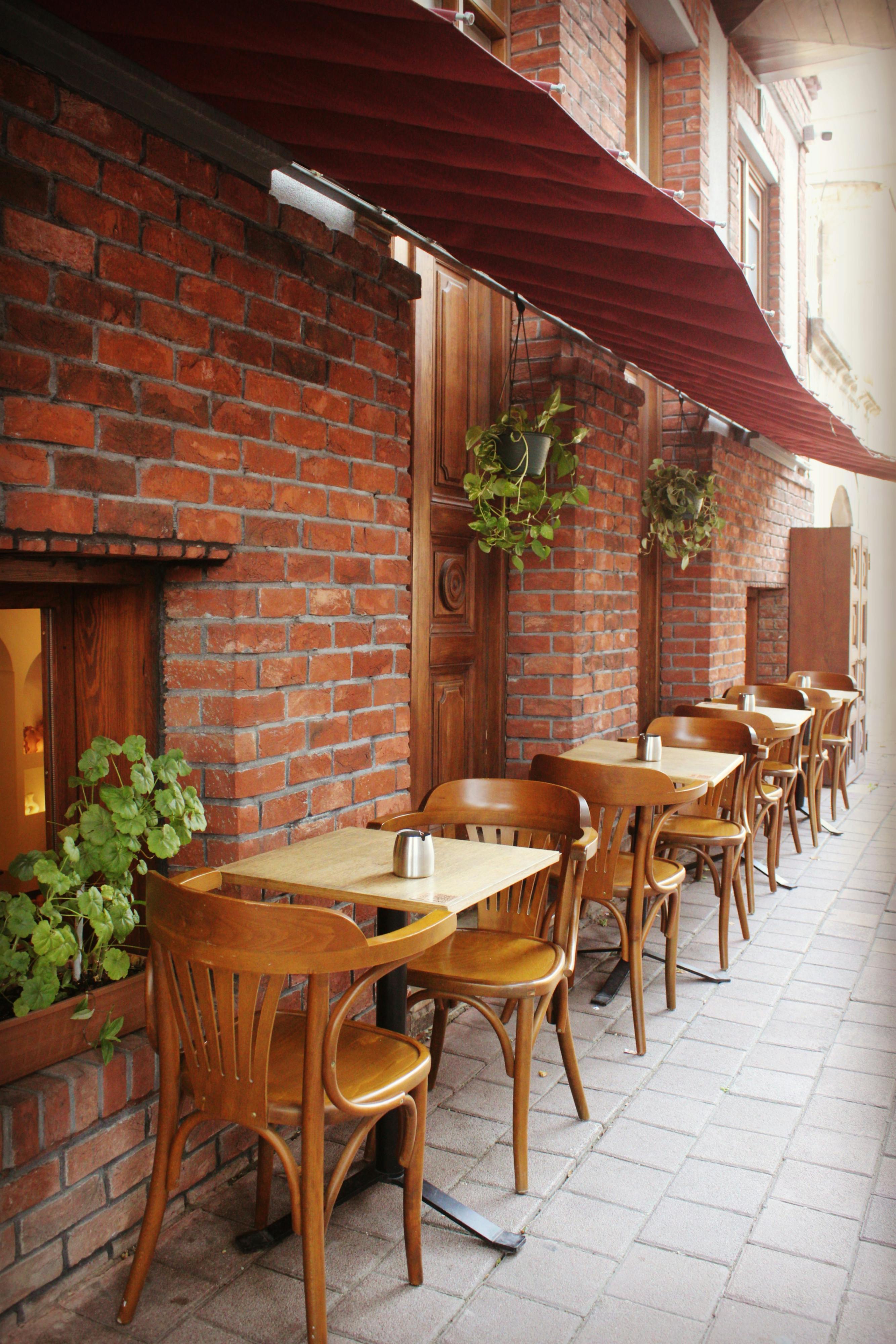Charming Outdoor Café with Brick Walls · Free Stock Photo