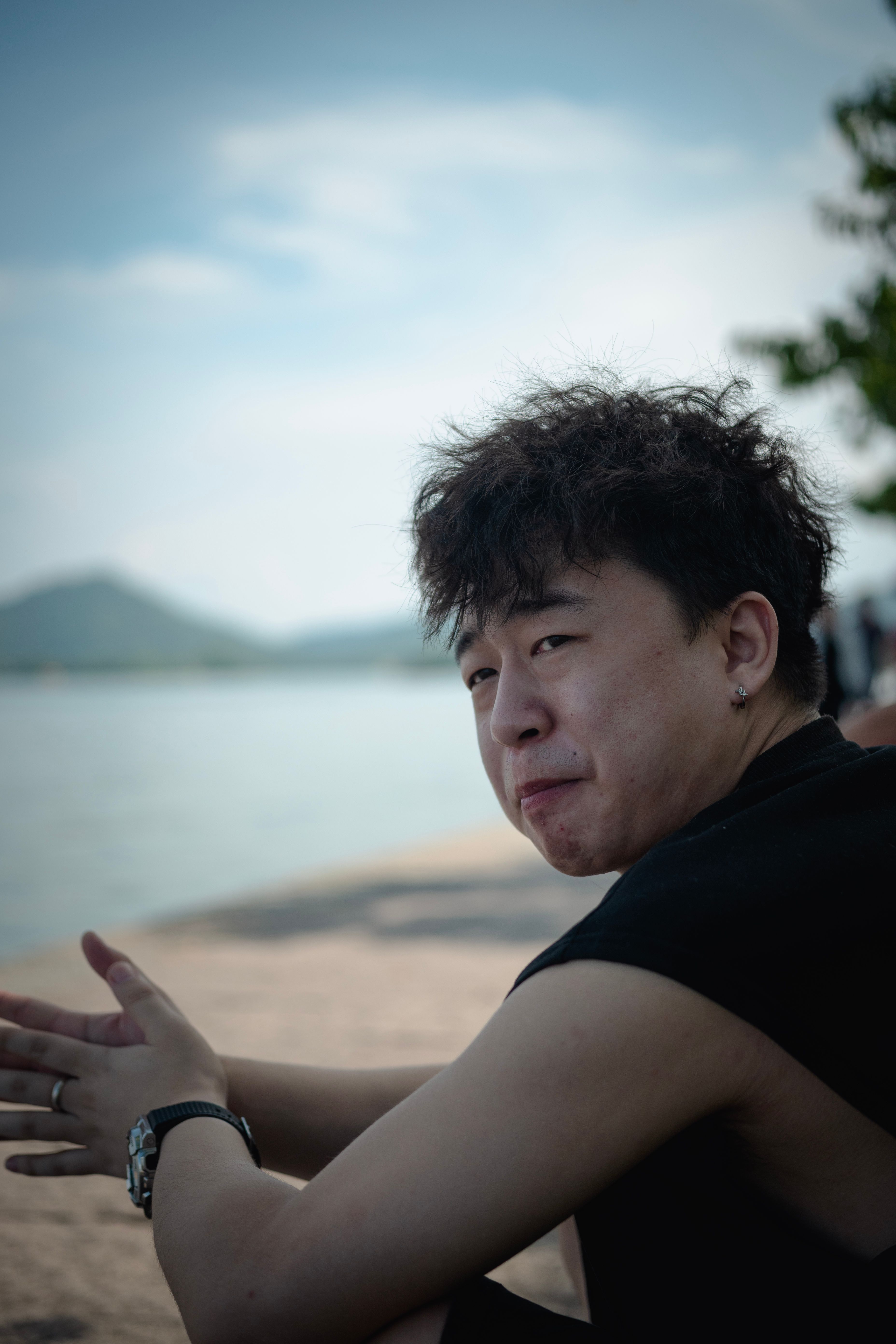 Young Man Relaxing by Tranquil Lakeside · Free Stock Photo