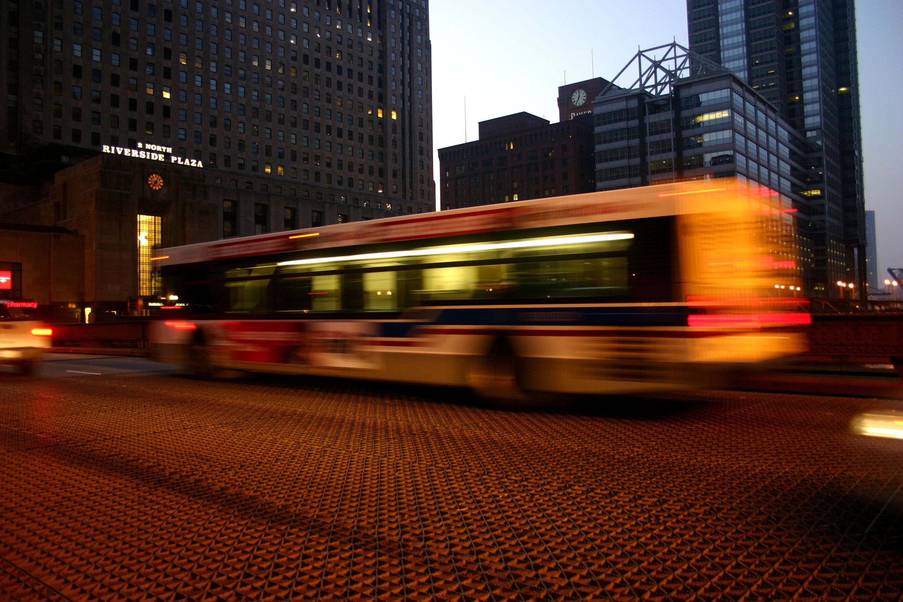Blurred City Bus at Night Near Riverside Plaza · Free Stock Photo