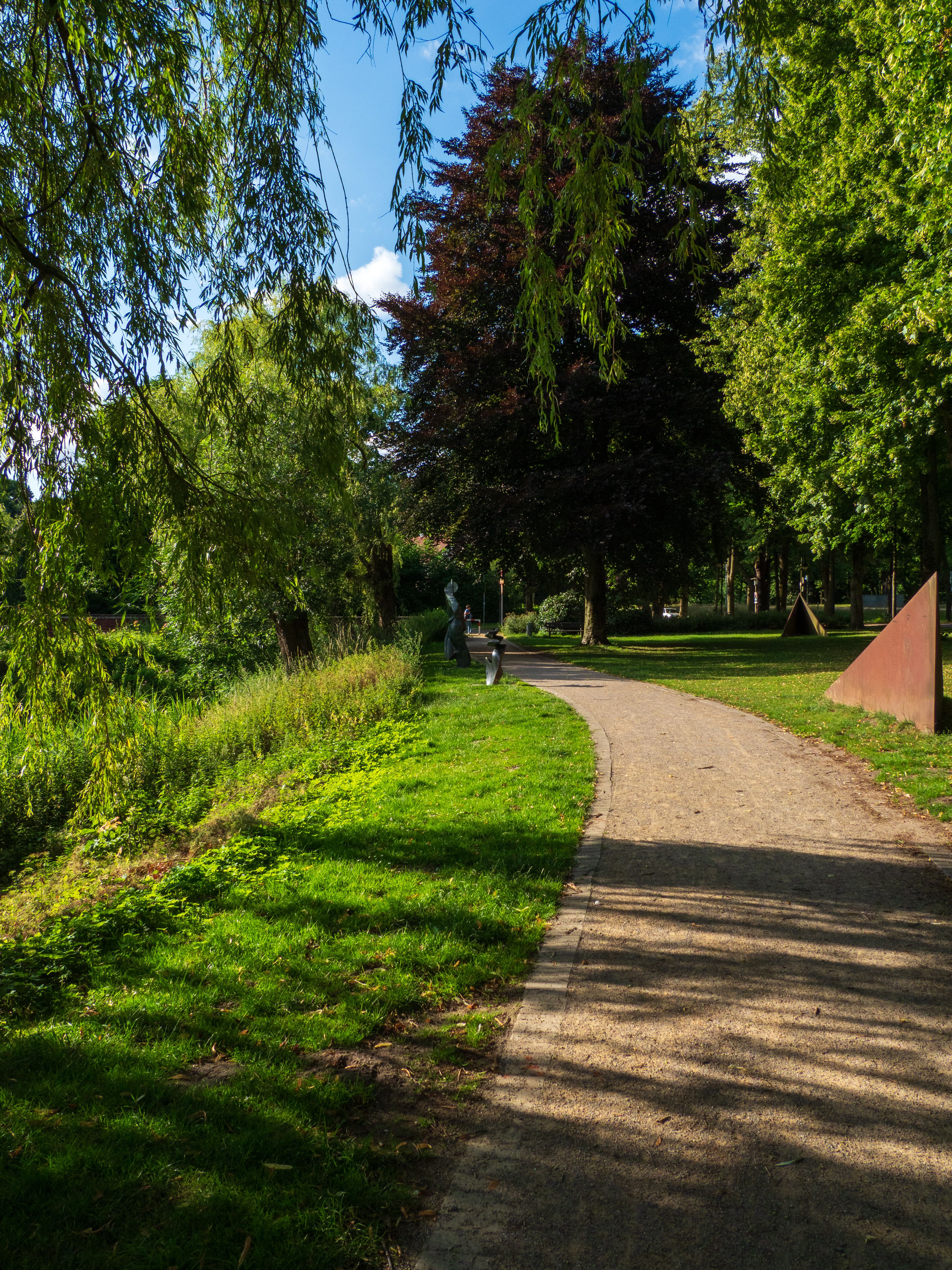 Sunny Pathway in a Serene Park Setting · Free Stock Photo
