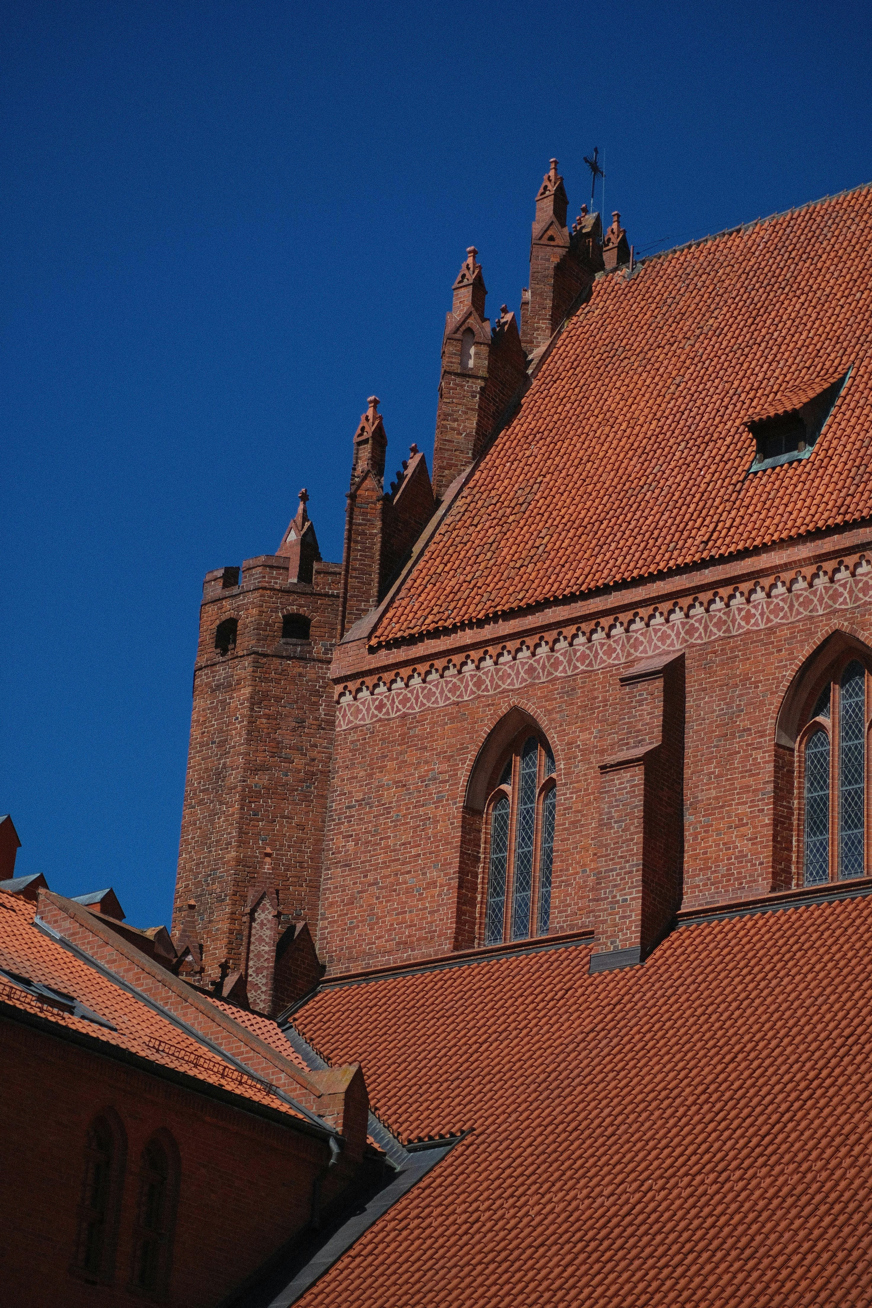 Red Brick Gothic Church with Blue Sky · Free Stock Photo