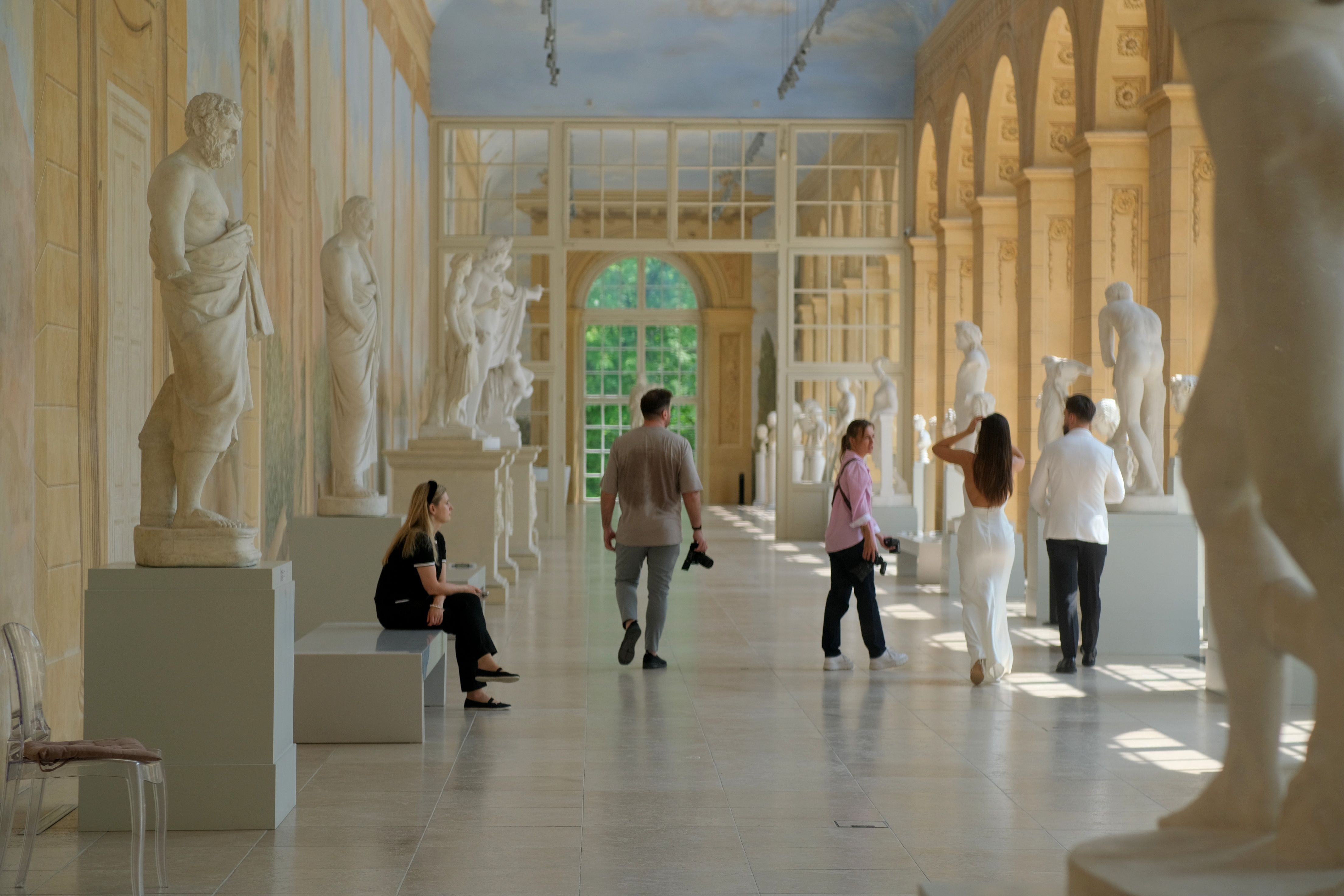 People Exploring a Classical Art Gallery · Free Stock Photo