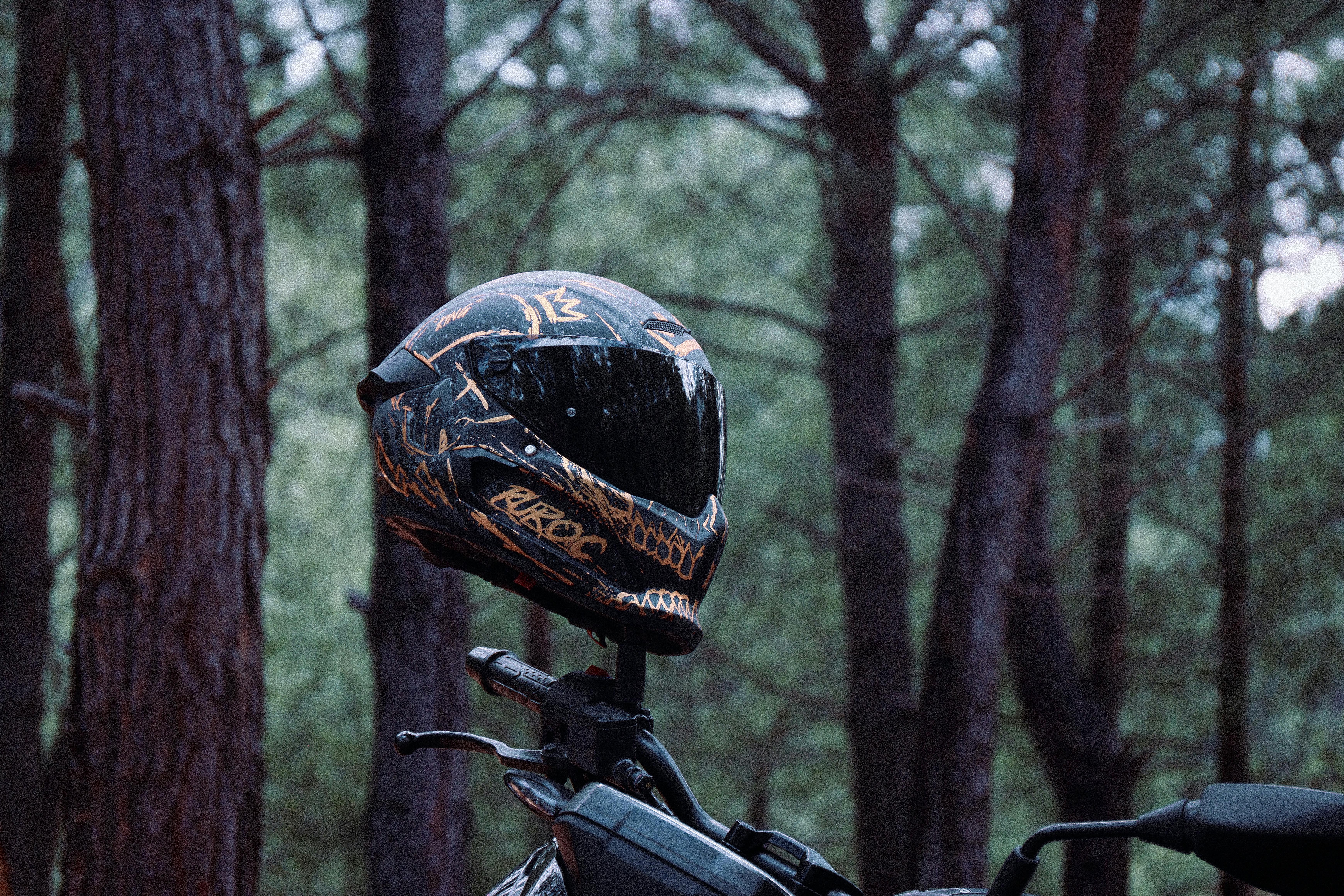 Motorcycle Helmet on Bike in Forest Setting · Free Stock Photo