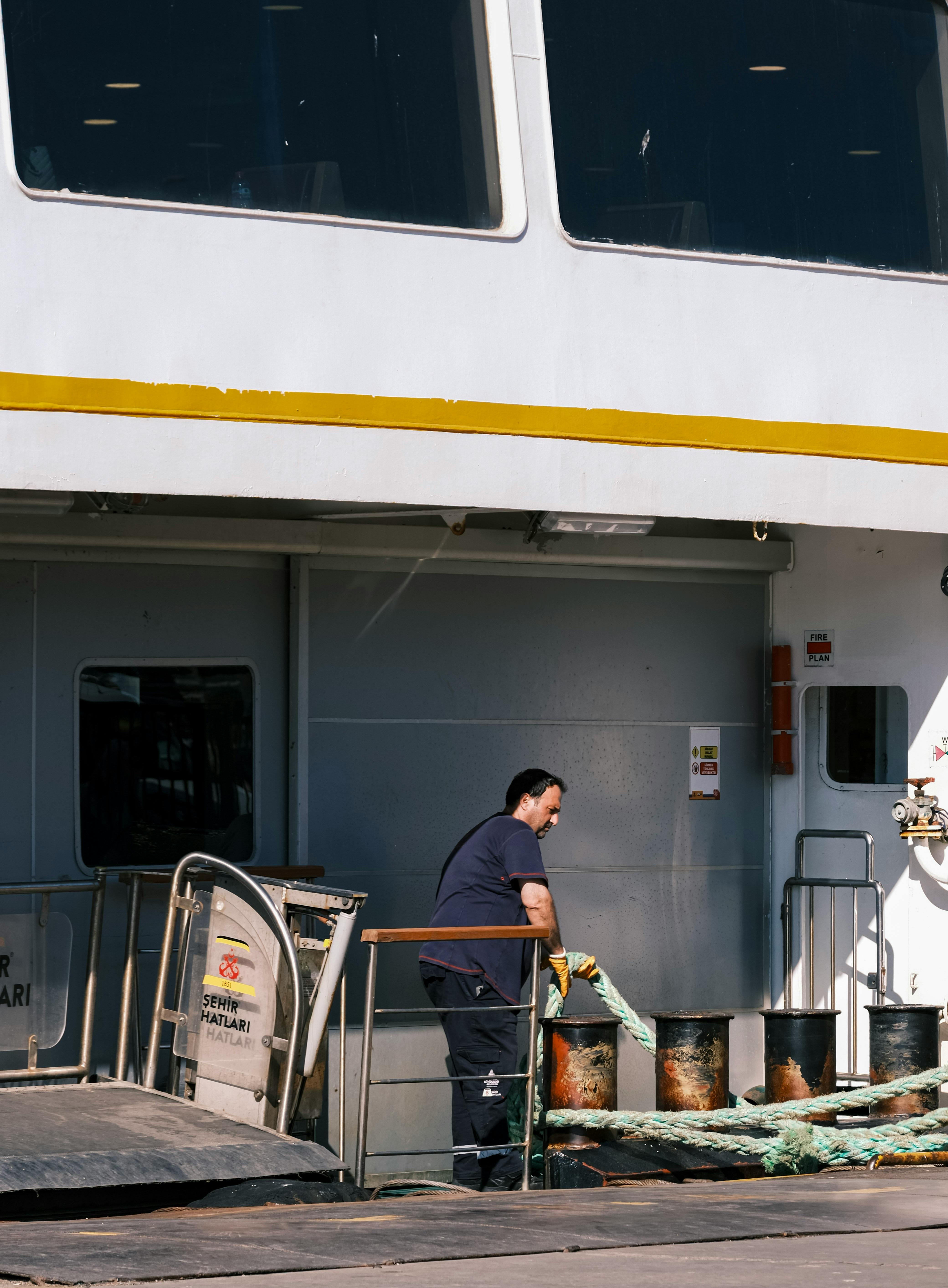 Worker Securing Ferry at Dock Side View · Free Stock Photo