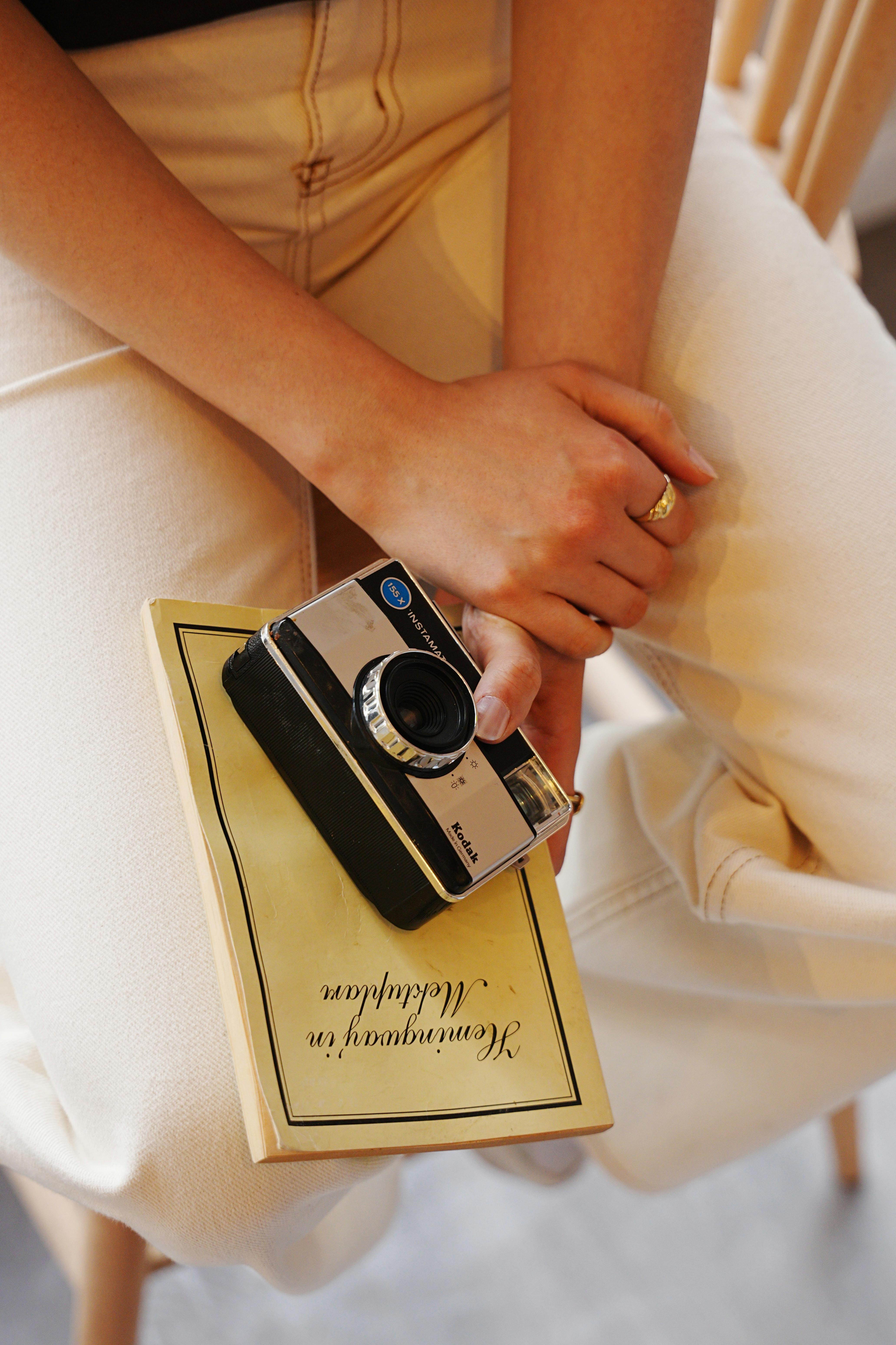Vintage Camera on Book in Warm Indoor Scene · Free Stock Photo