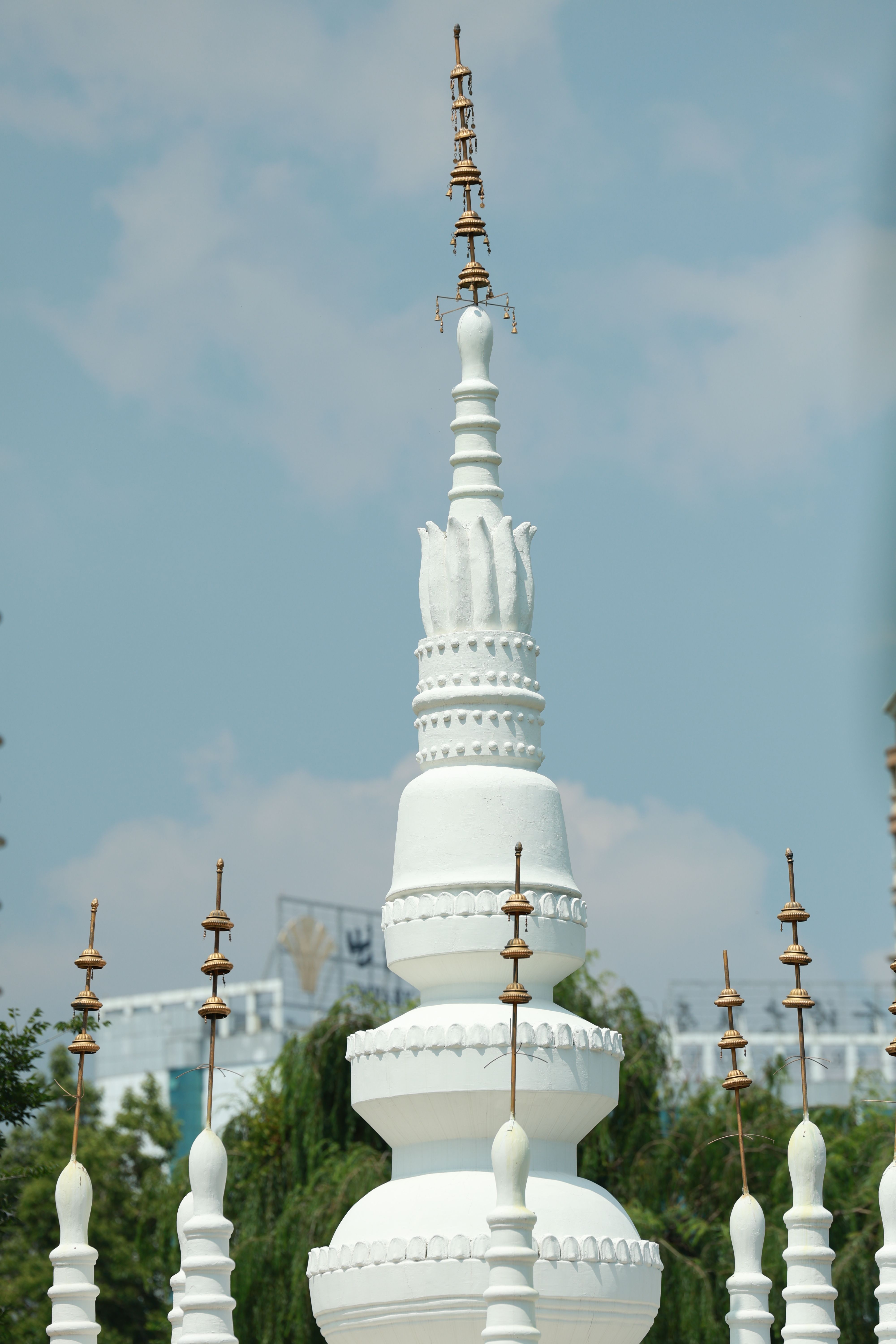 Intricately Designed White Temple Spire Against Blue Sky · Free Stock Photo