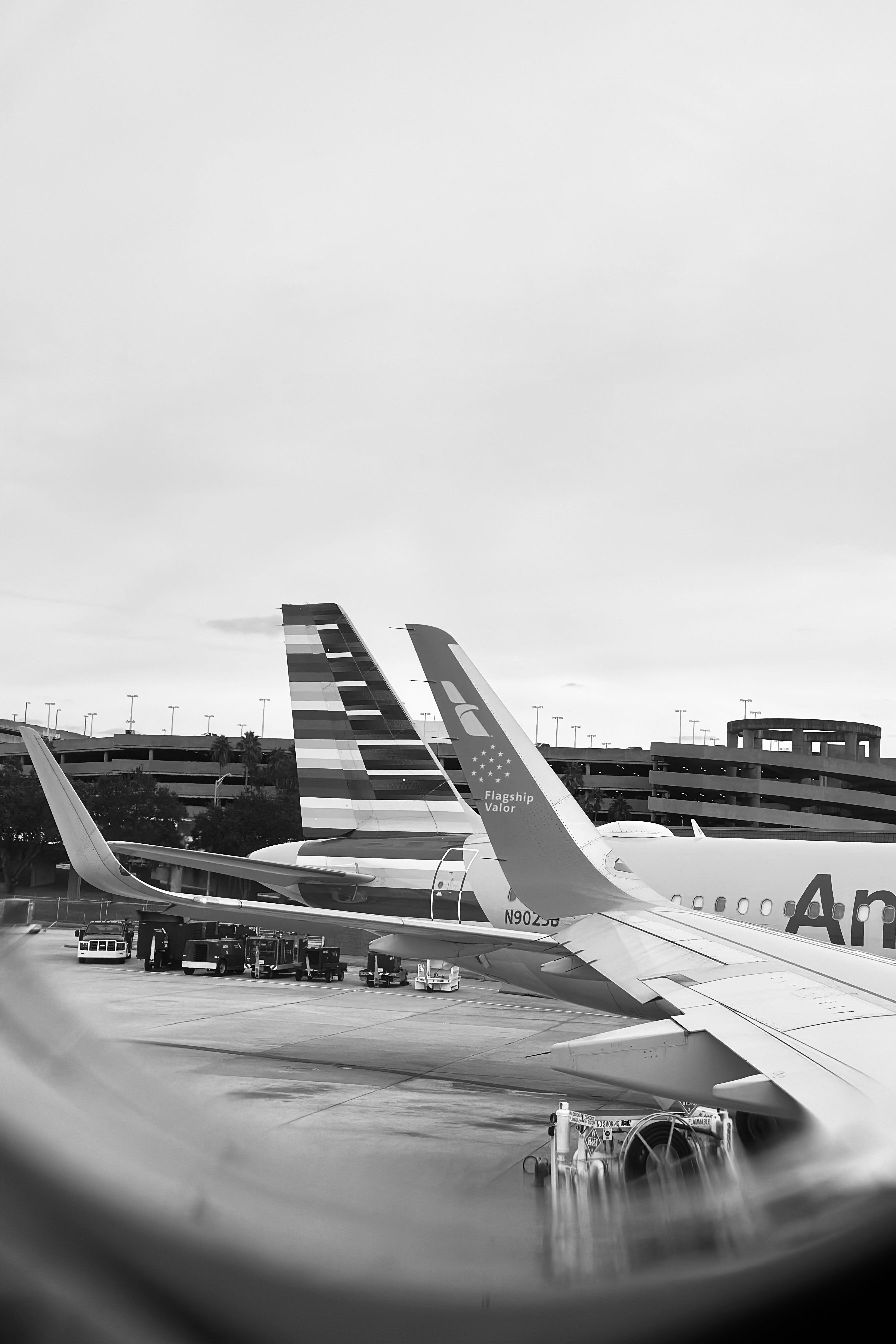 Gray Scale of Air Plane on Runway Under Cloudy Day · Free Stock Photo