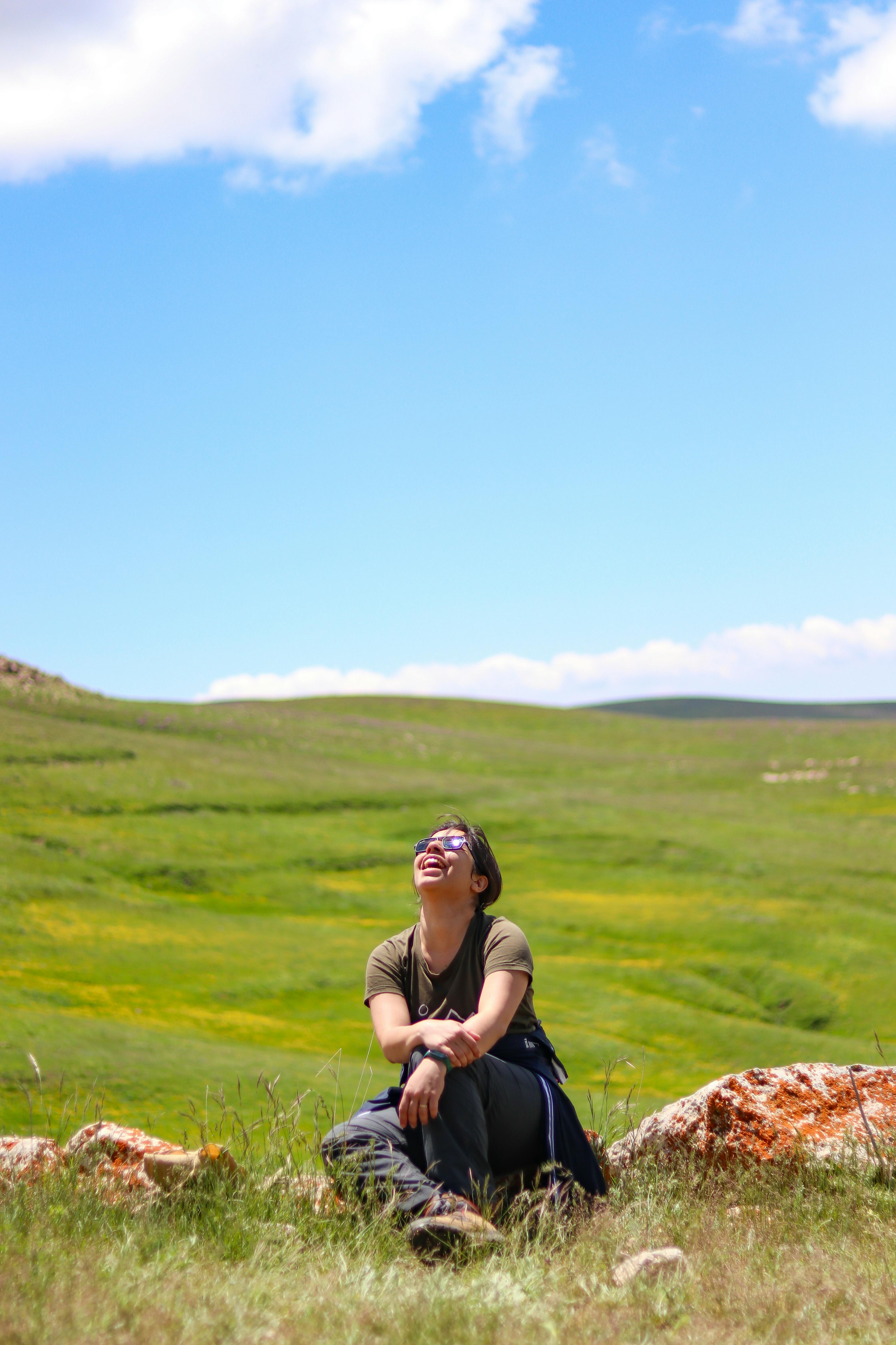 Woman Enjoying Nature in Sunny Meadow · Free Stock Photo