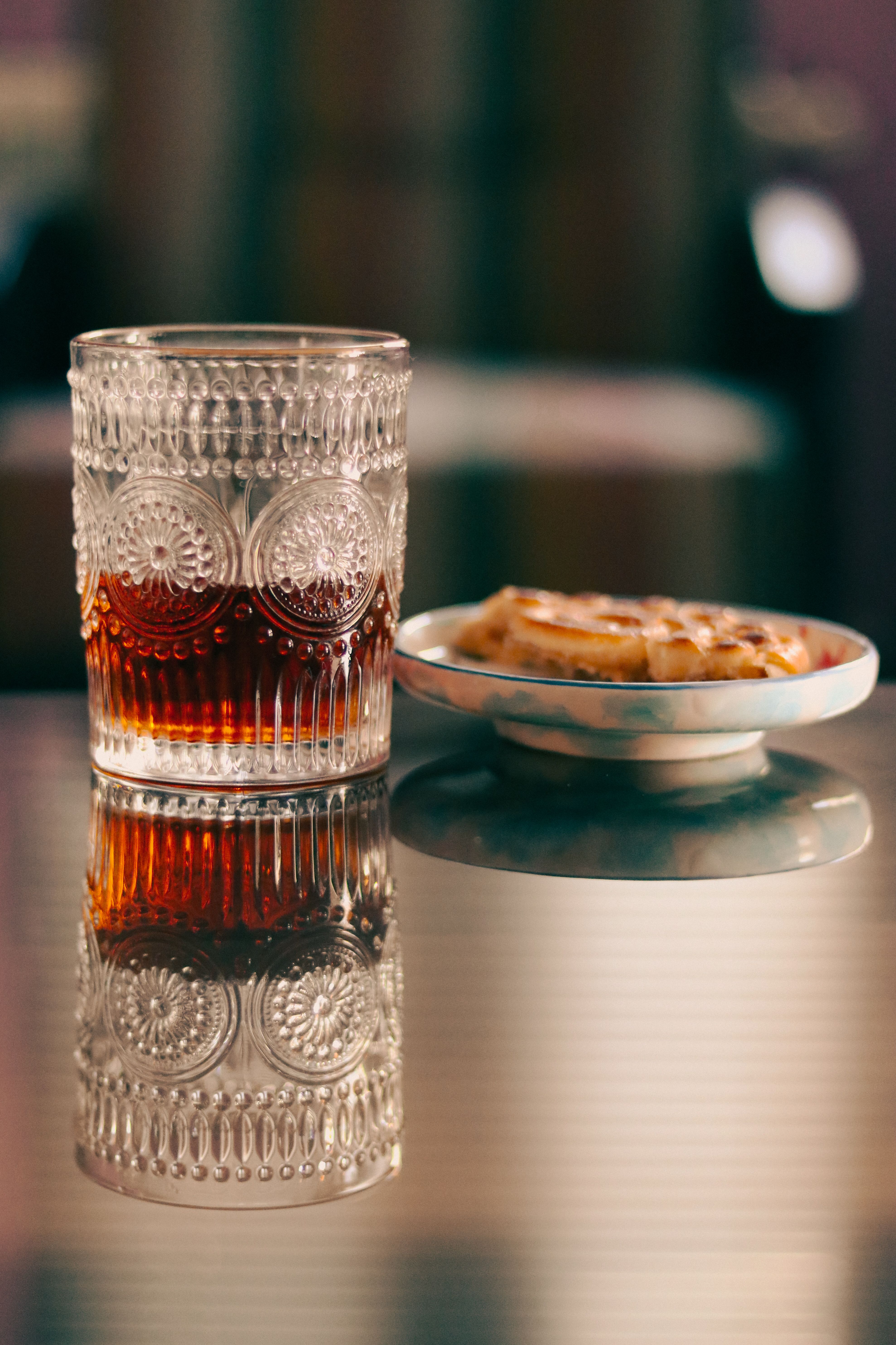 Elegant Glass of Tea with Biscuit on Table · Free Stock Photo