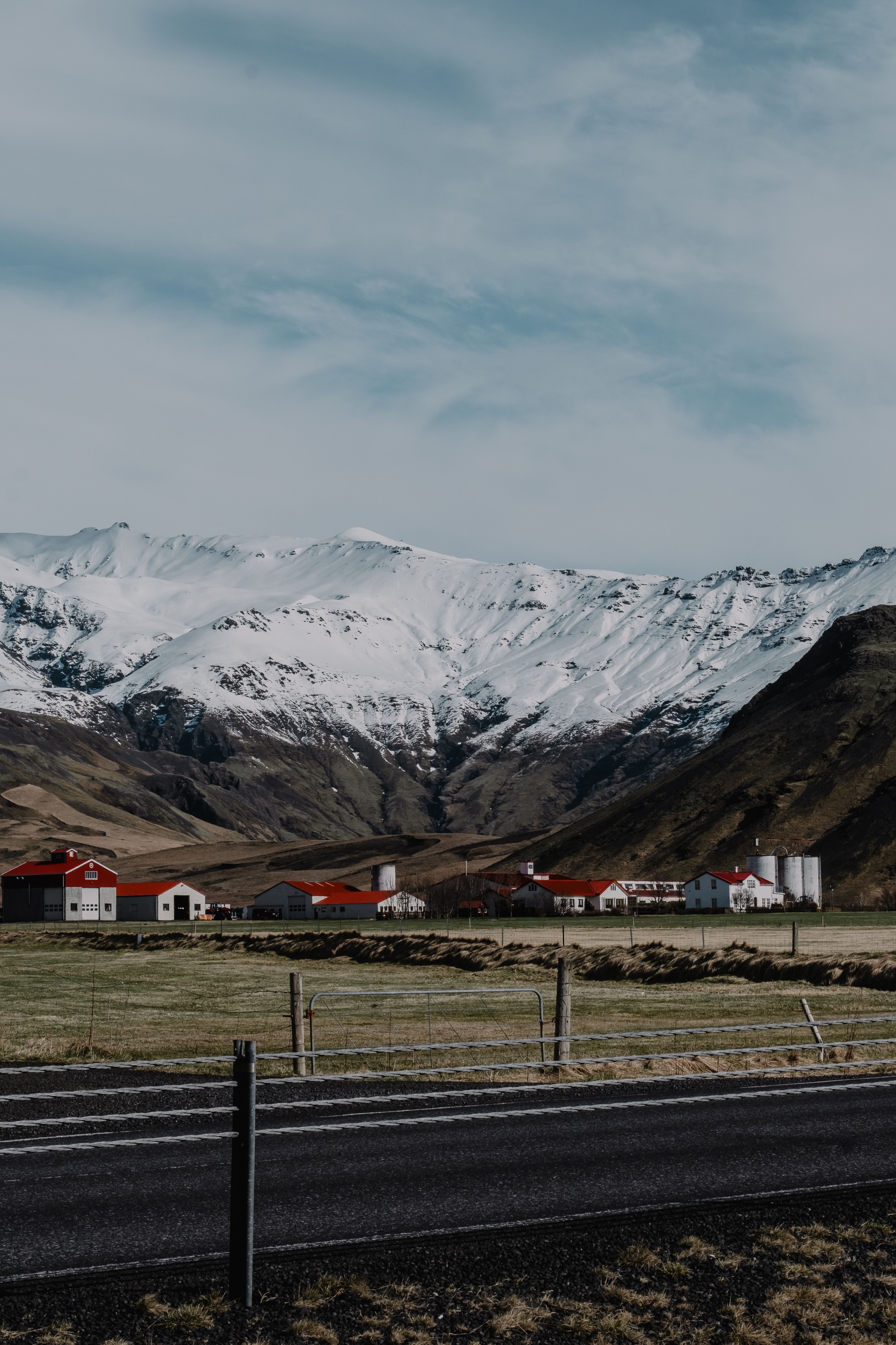 Rural Icelandic Village with Snow-Capped Mountains · Free Stock Photo