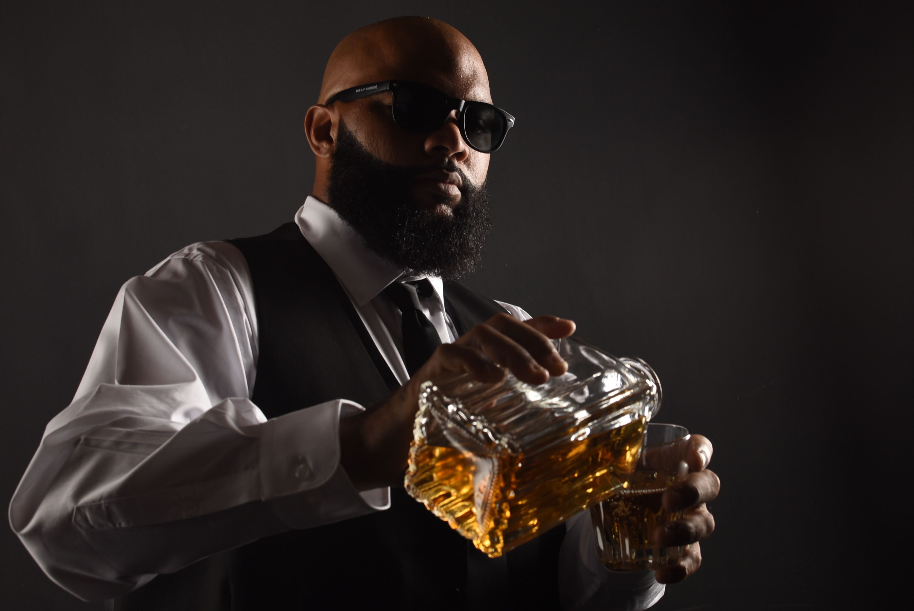 Stylish Man Pouring Whiskey in Elegant Setting · Free Stock Photo