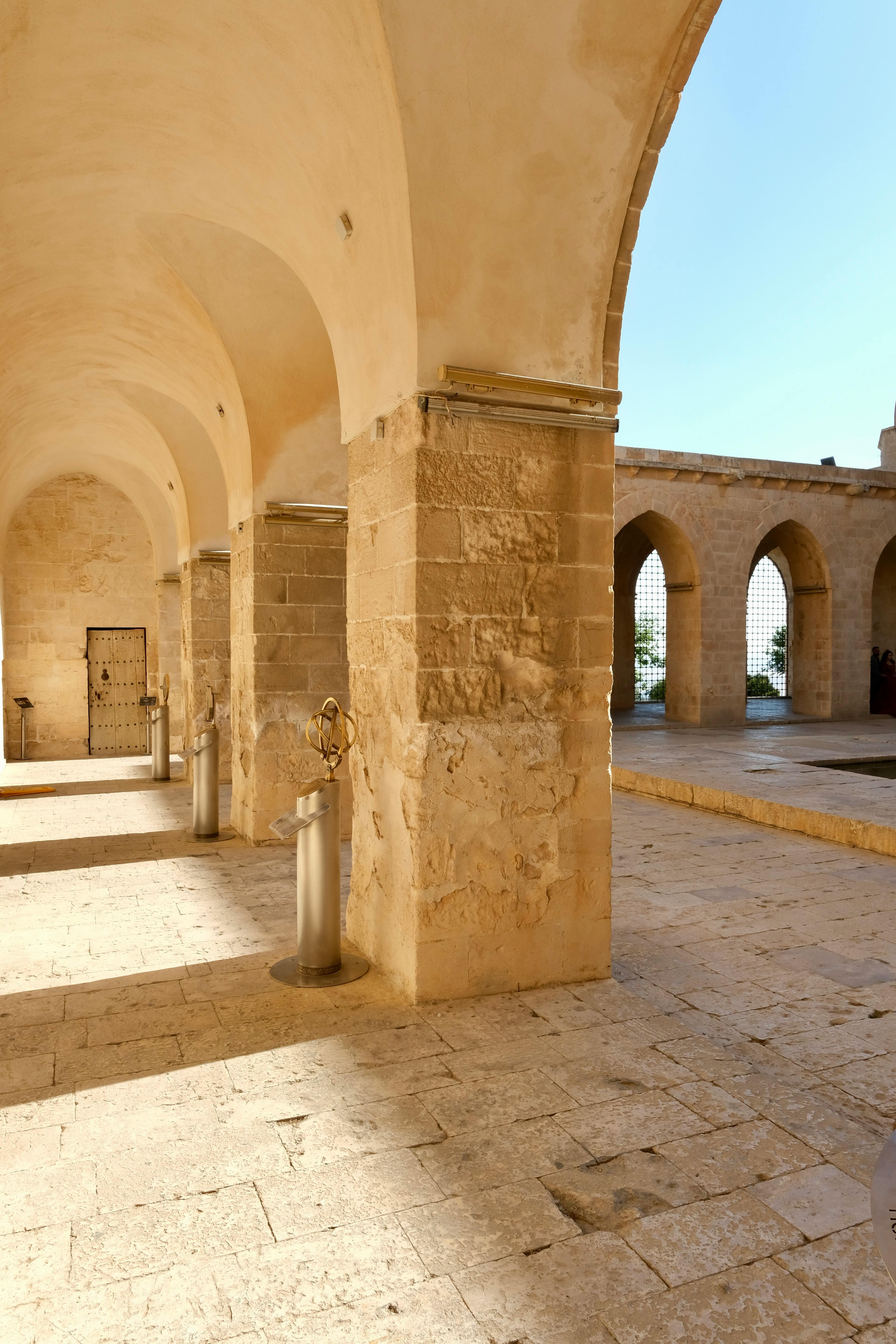 Historic Stone Arched Passageway in Sunlight · Free Stock Photo