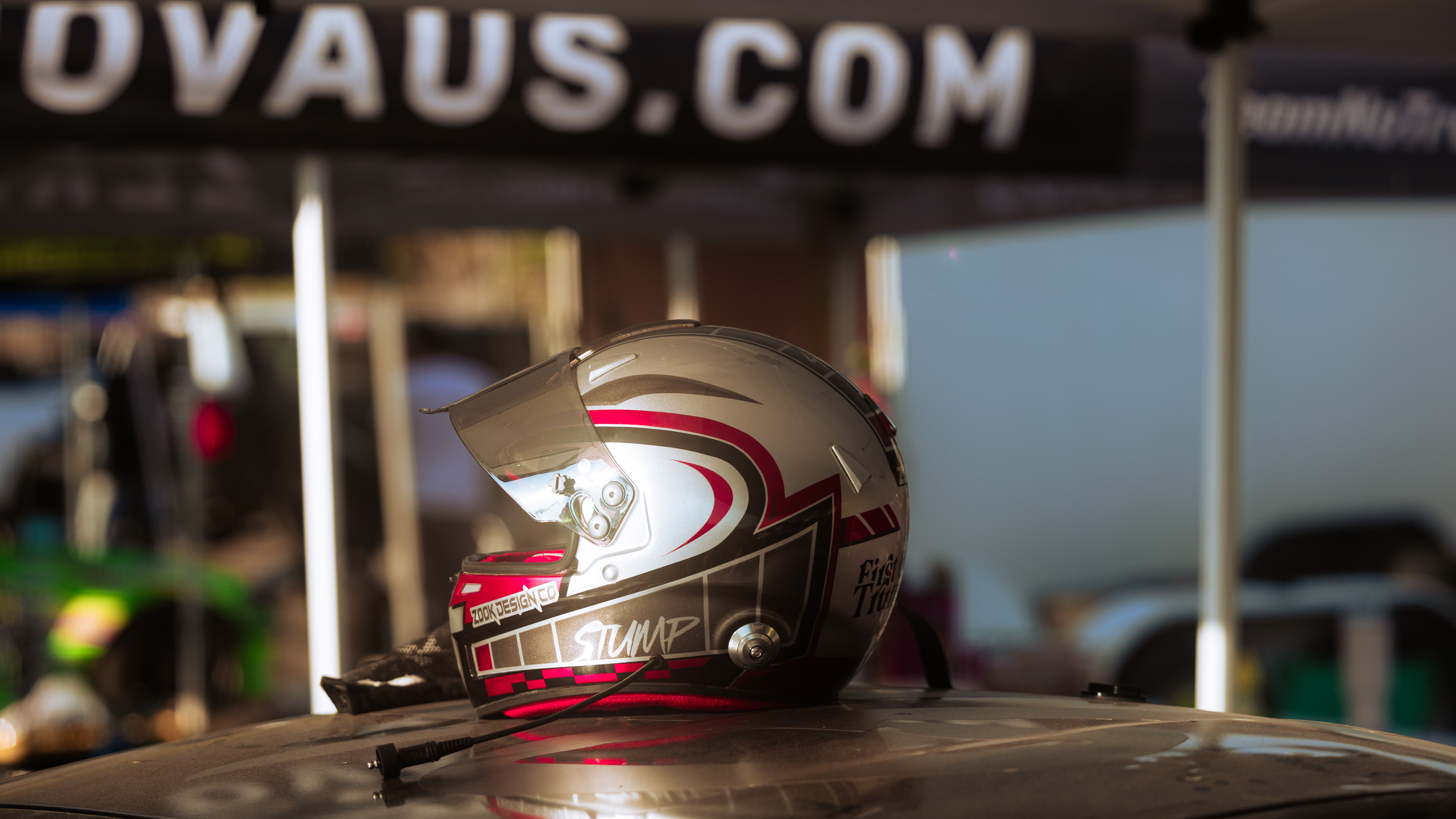 Racing Helmet on Car at Outdoor Event · Free Stock Photo