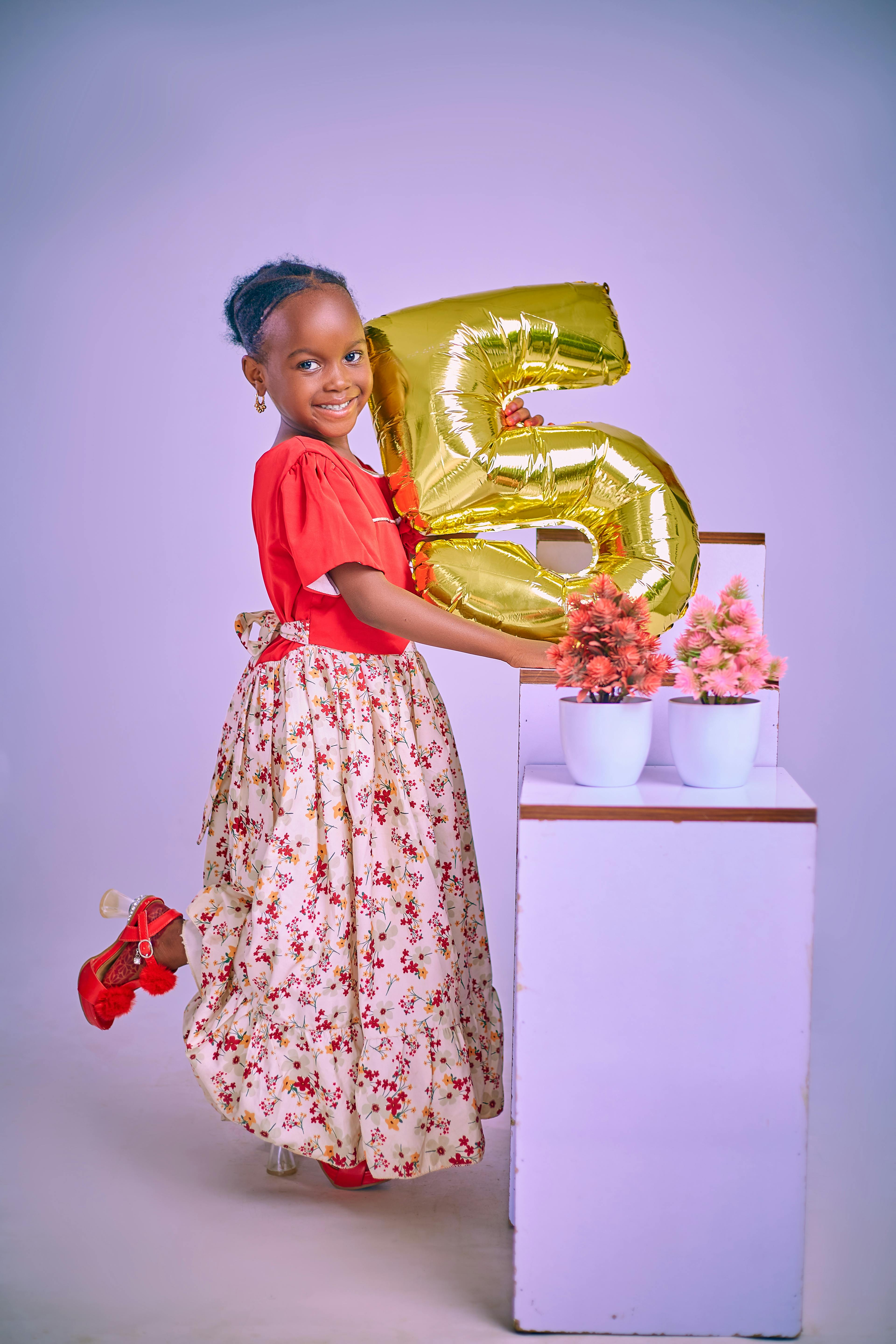 Smiling Girl Holding Golden Number Five Balloon · Free Stock Photo