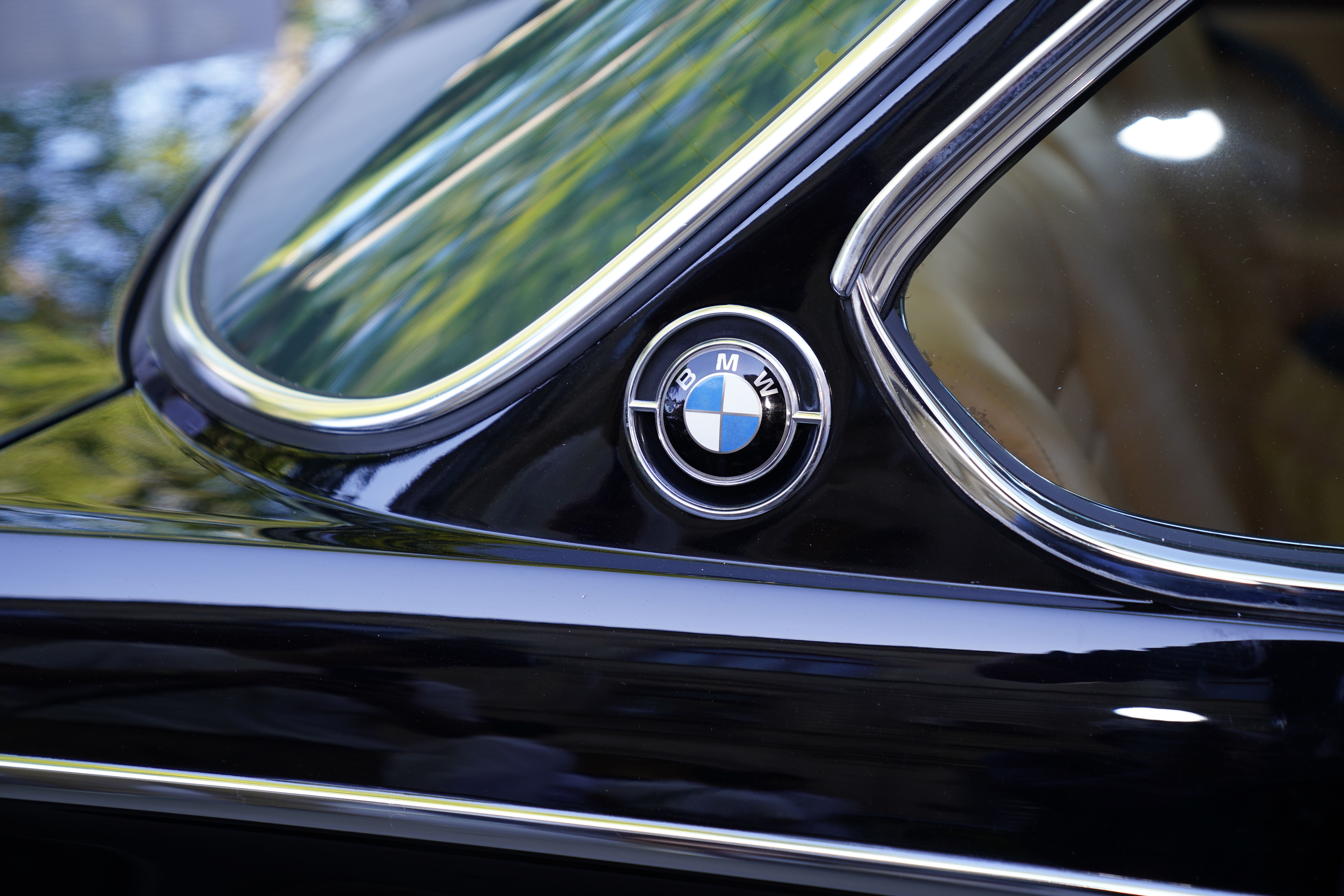 Close-up of Vintage Car Window and Emblem · Free Stock Photo