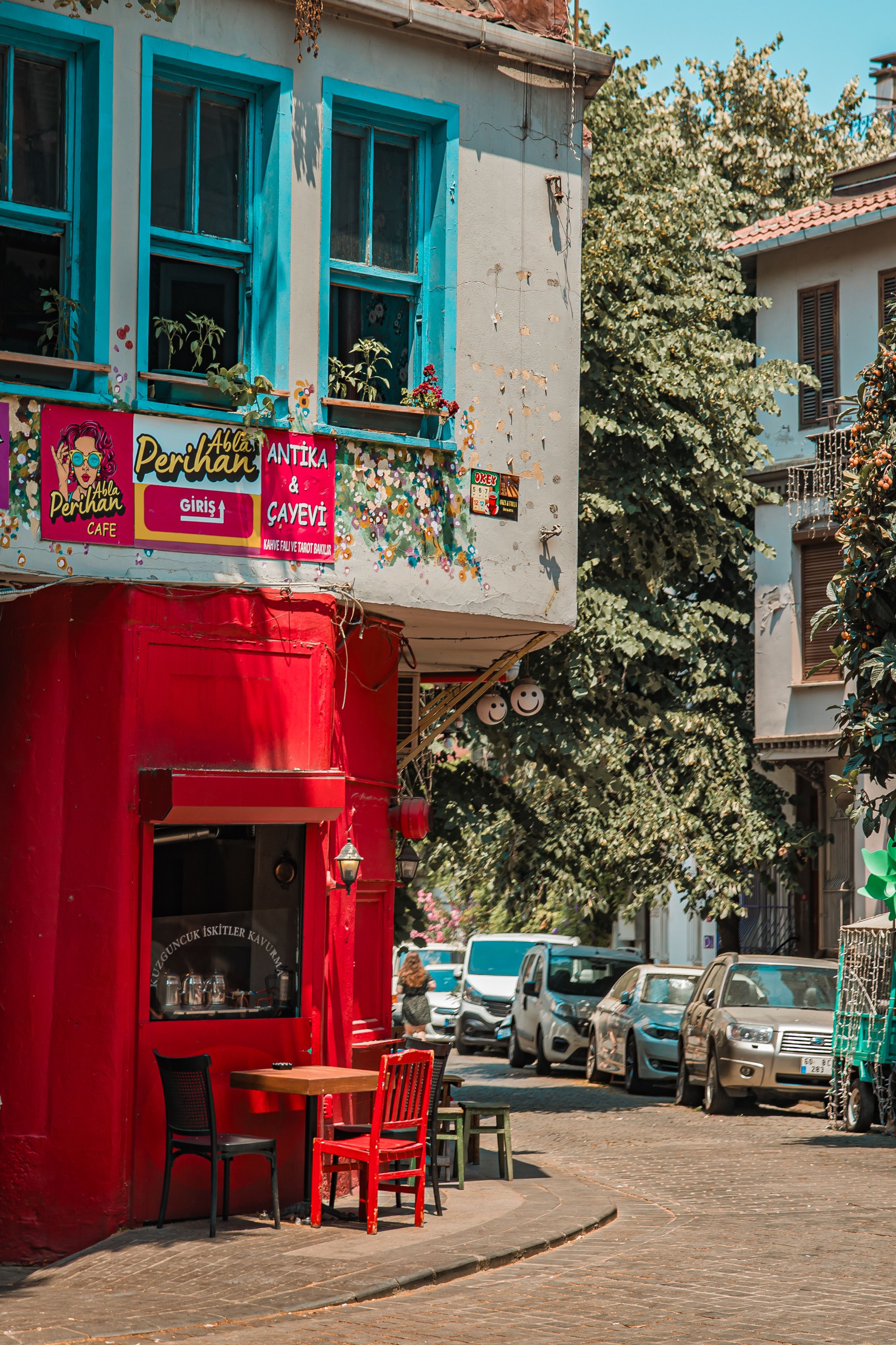 Charming Street Corner Cafe with Red Facade · Free Stock Photo