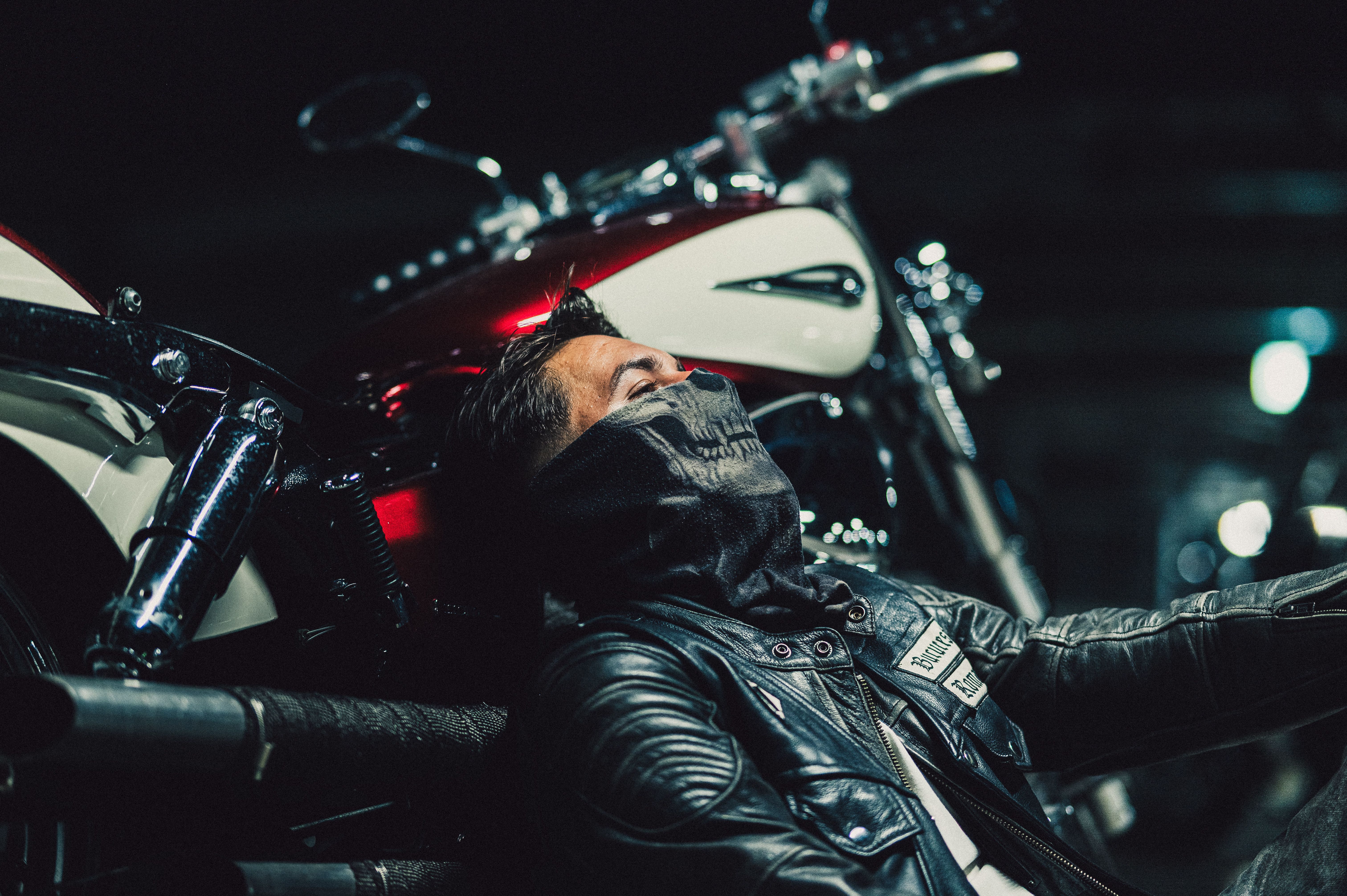 Rugged Biker Relaxing Beside Motorcycle at Night · Free Stock Photo