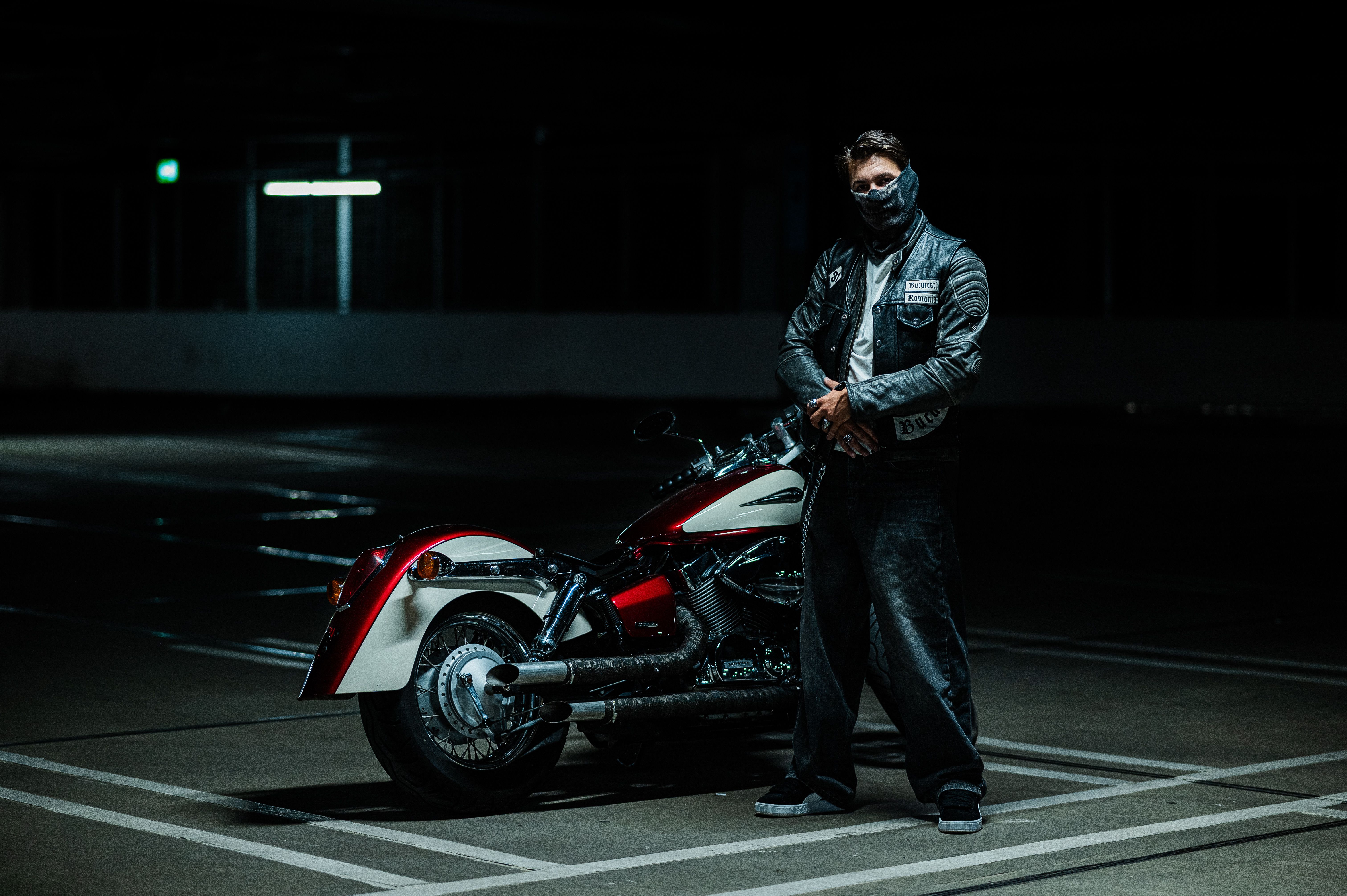 Biker in Dark Garage with Classic Motorcycle · Free Stock Photo