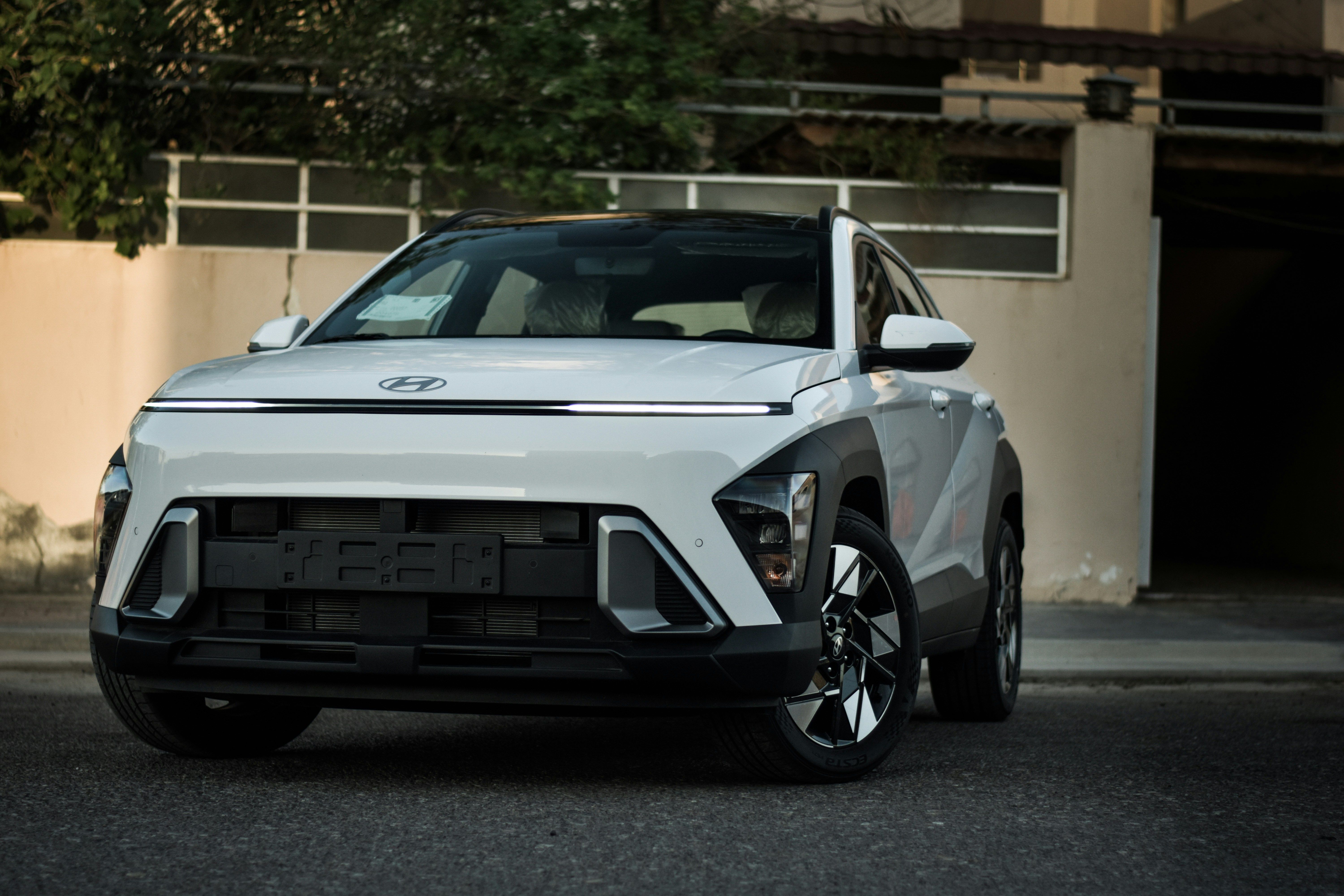 Sleek White SUV Parked on Street in Urban Setting · Free Stock Photo