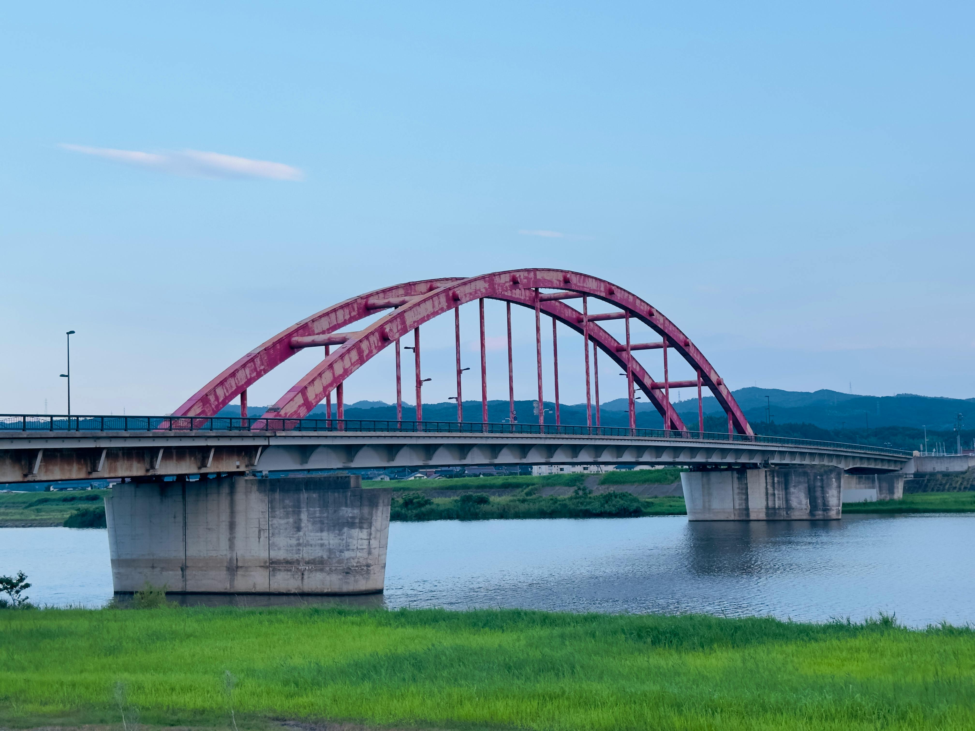 Scenic Red Arch Bridge Over Tranquil River · Free Stock Photo