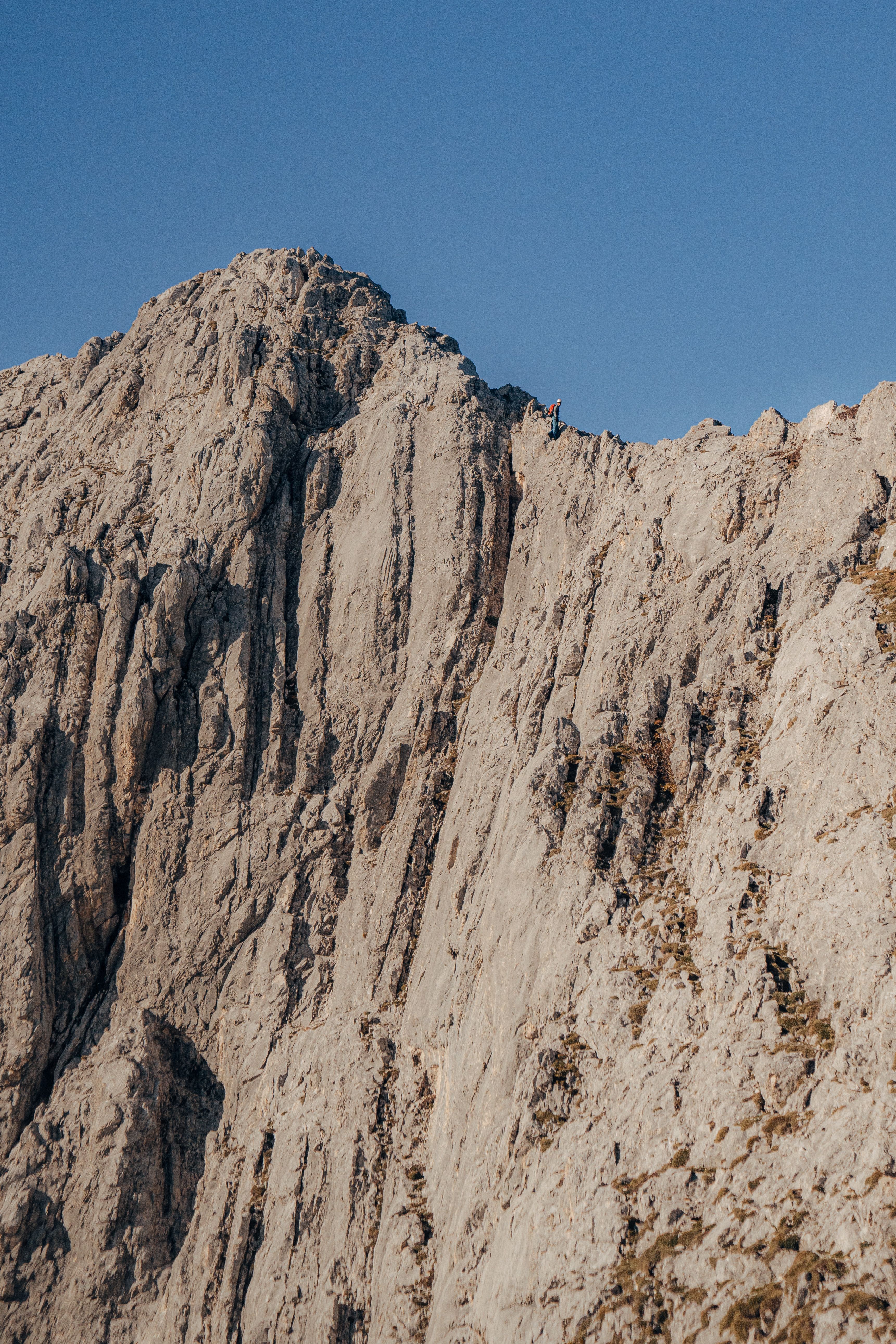 Majestic Limestone Mountain Cliff Under Blue Sky · Free Stock Photo