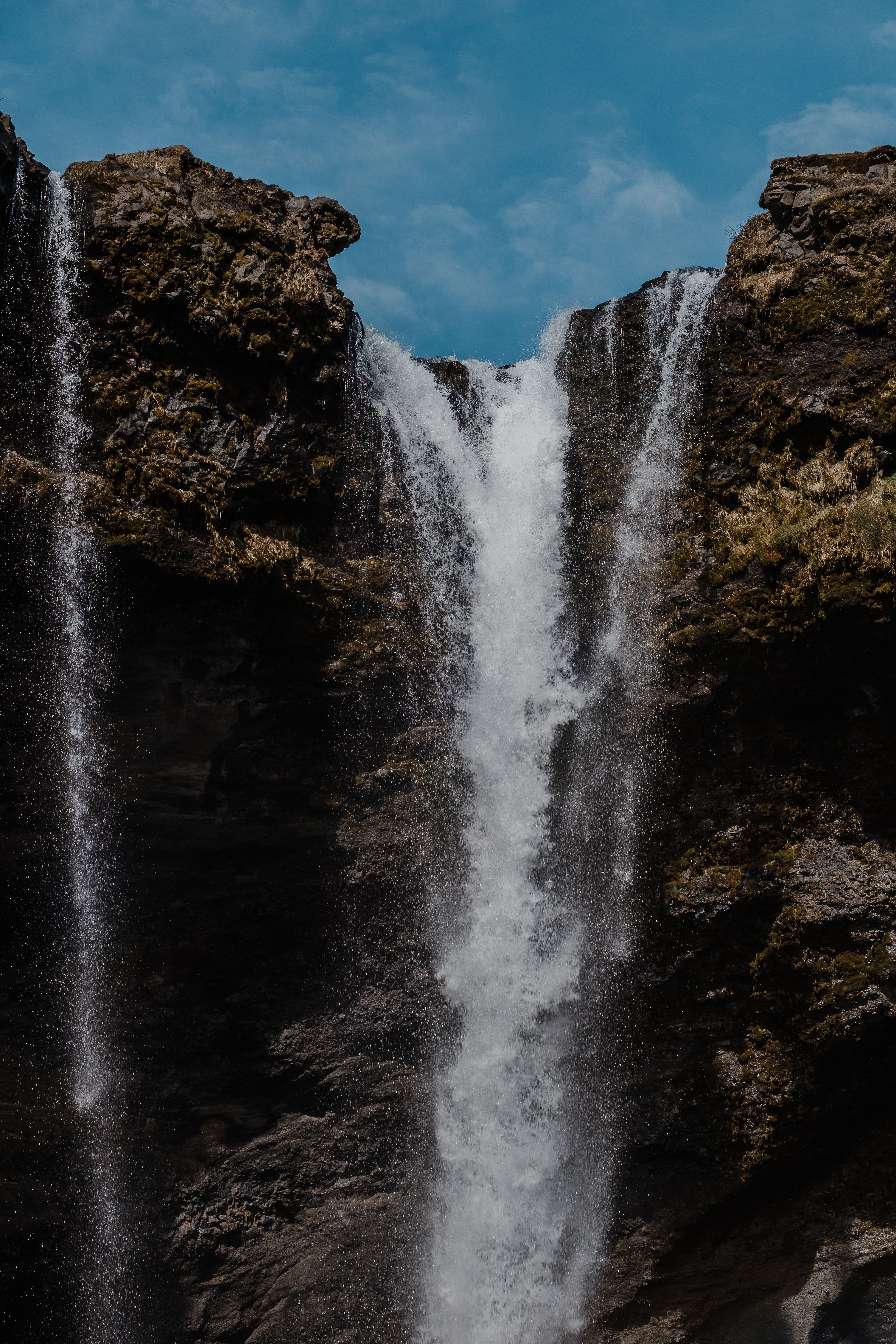 Majestic Waterfall Cascading Between Rocky Cliffs · Free Stock Photo