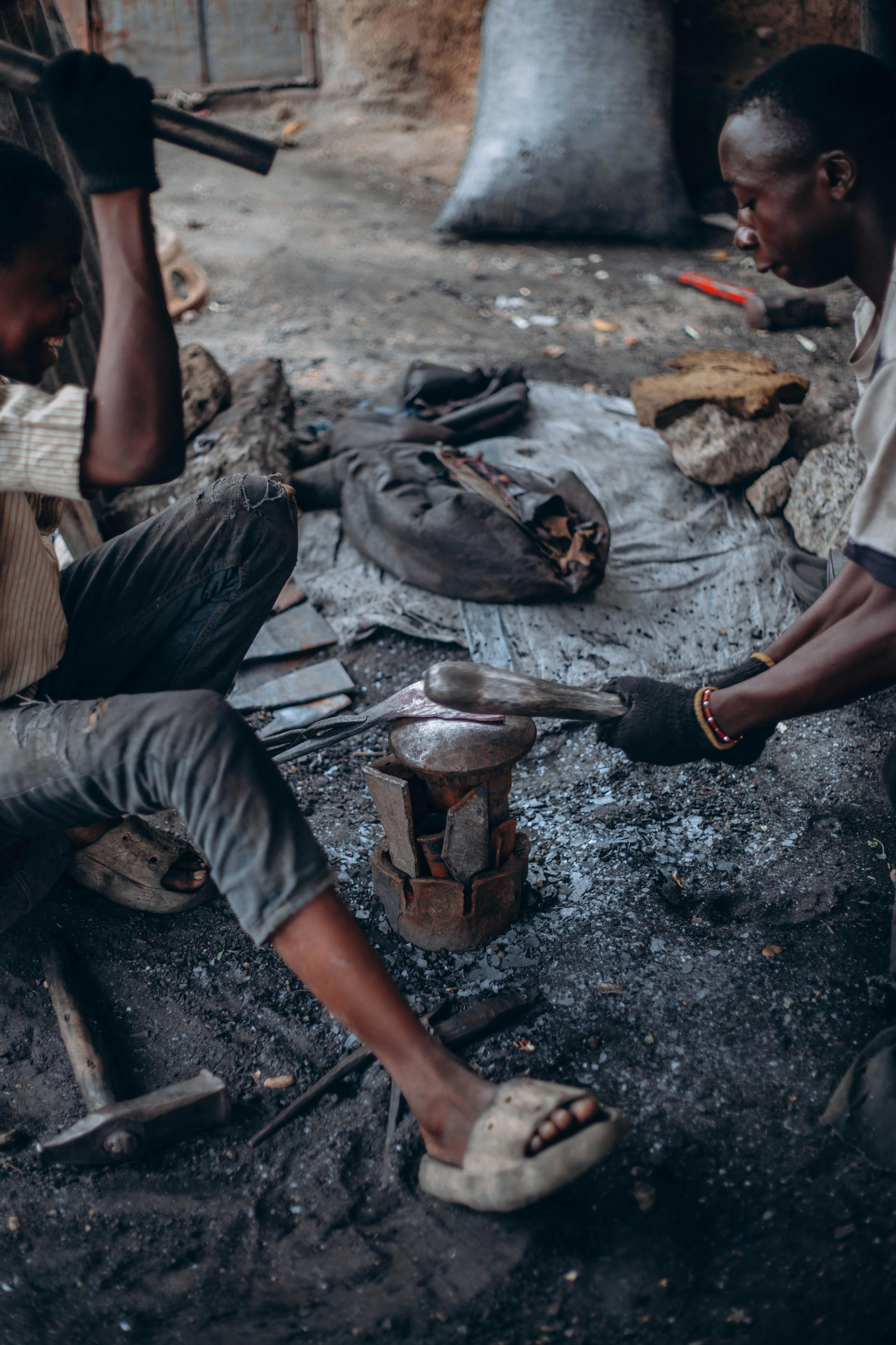 African Blacksmiths at Work in Outdoor Forge · Free Stock Photo
