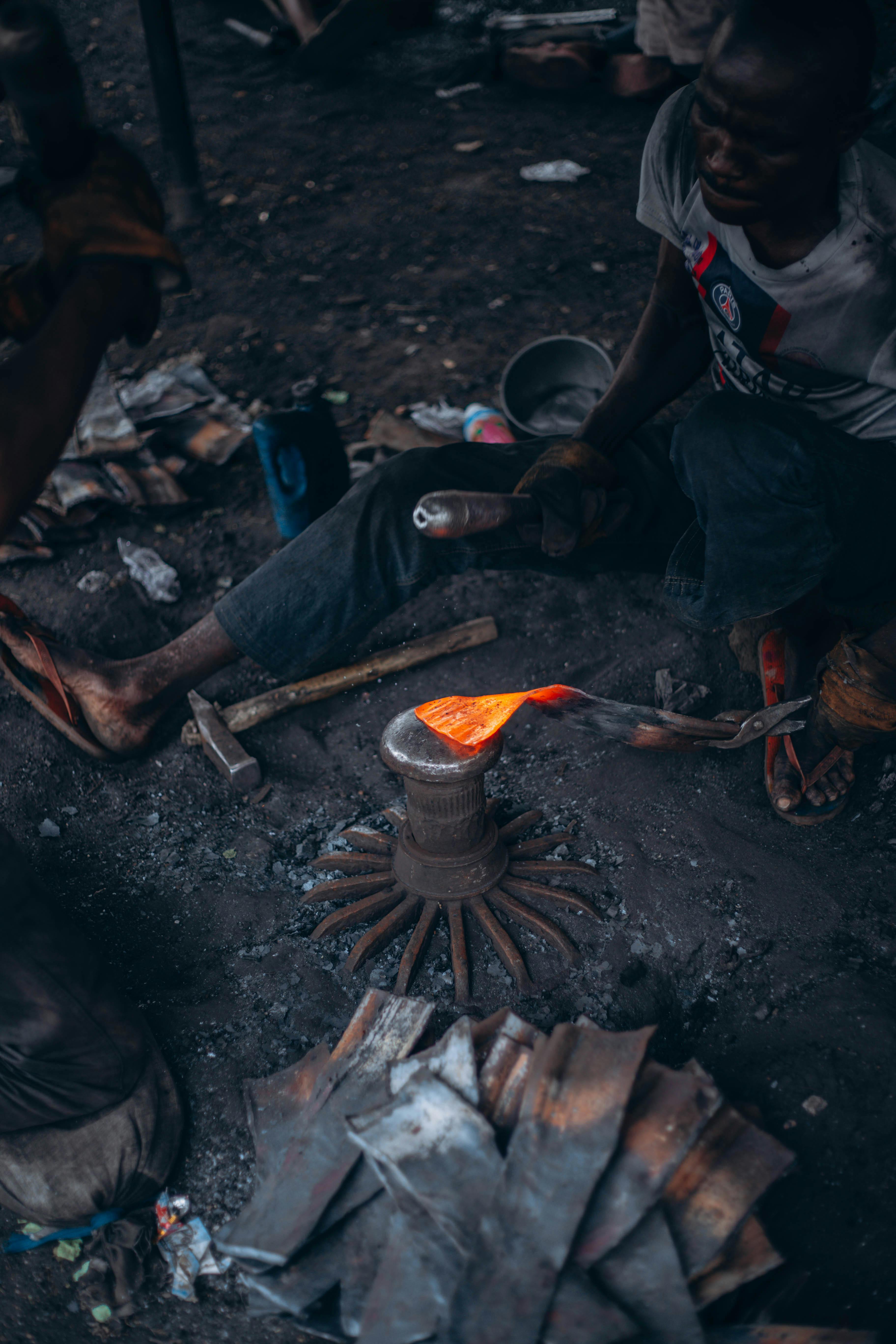 Blacksmith Crafting Iron in Rustic Workshop · Free Stock Photo