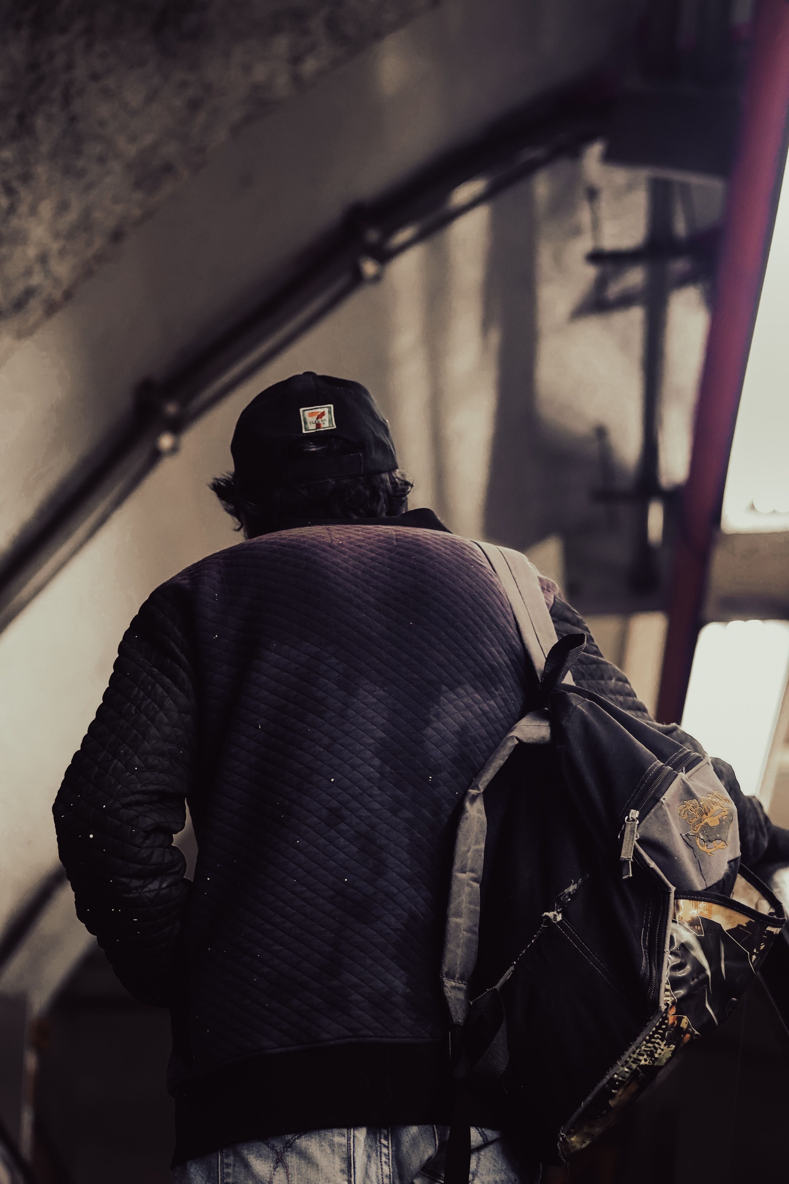 Back view of a person with a backpack in urban setting · Free Stock Photo