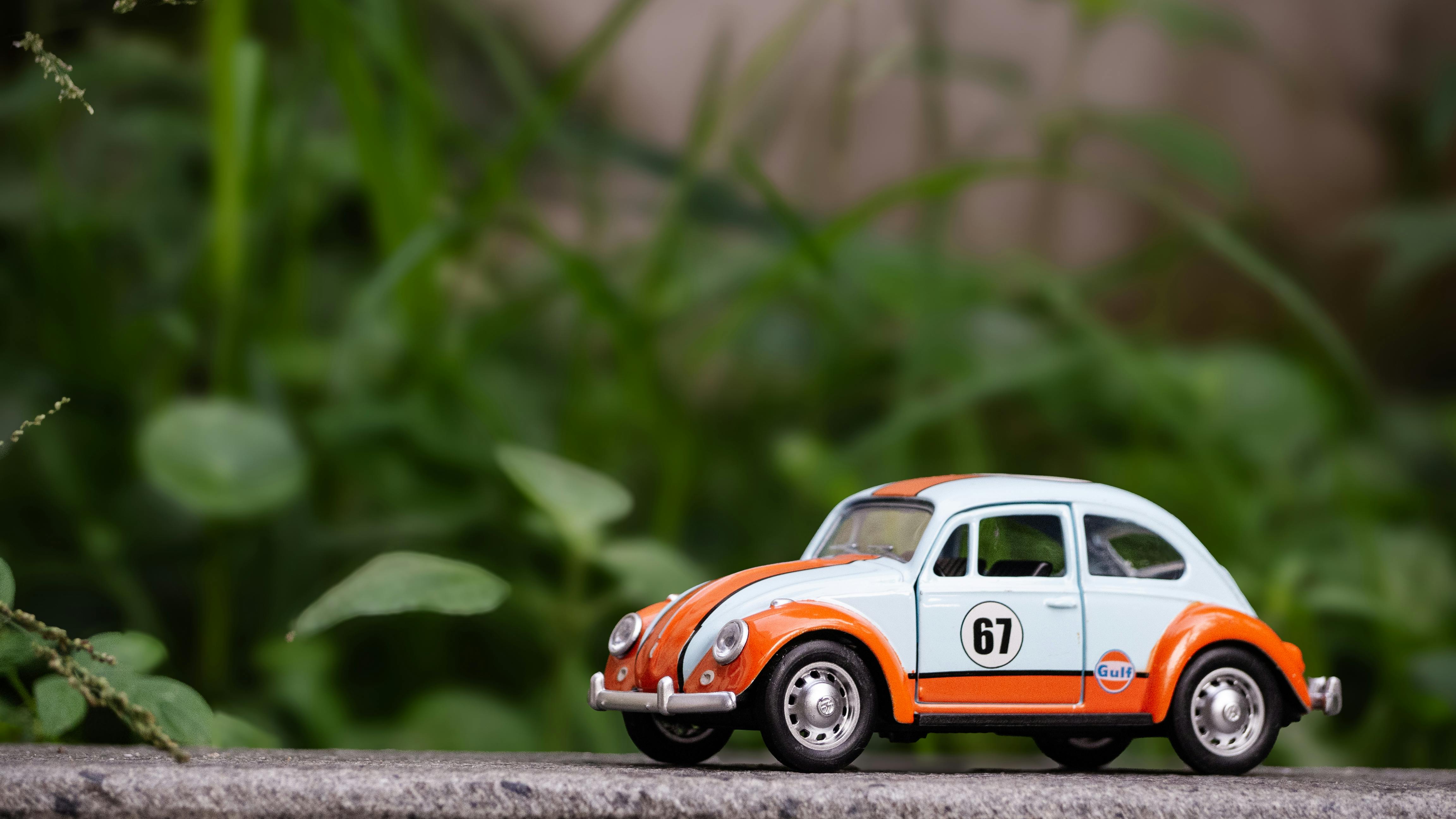 Green Scale Model Car on Brown Pavement · Free Stock Photo