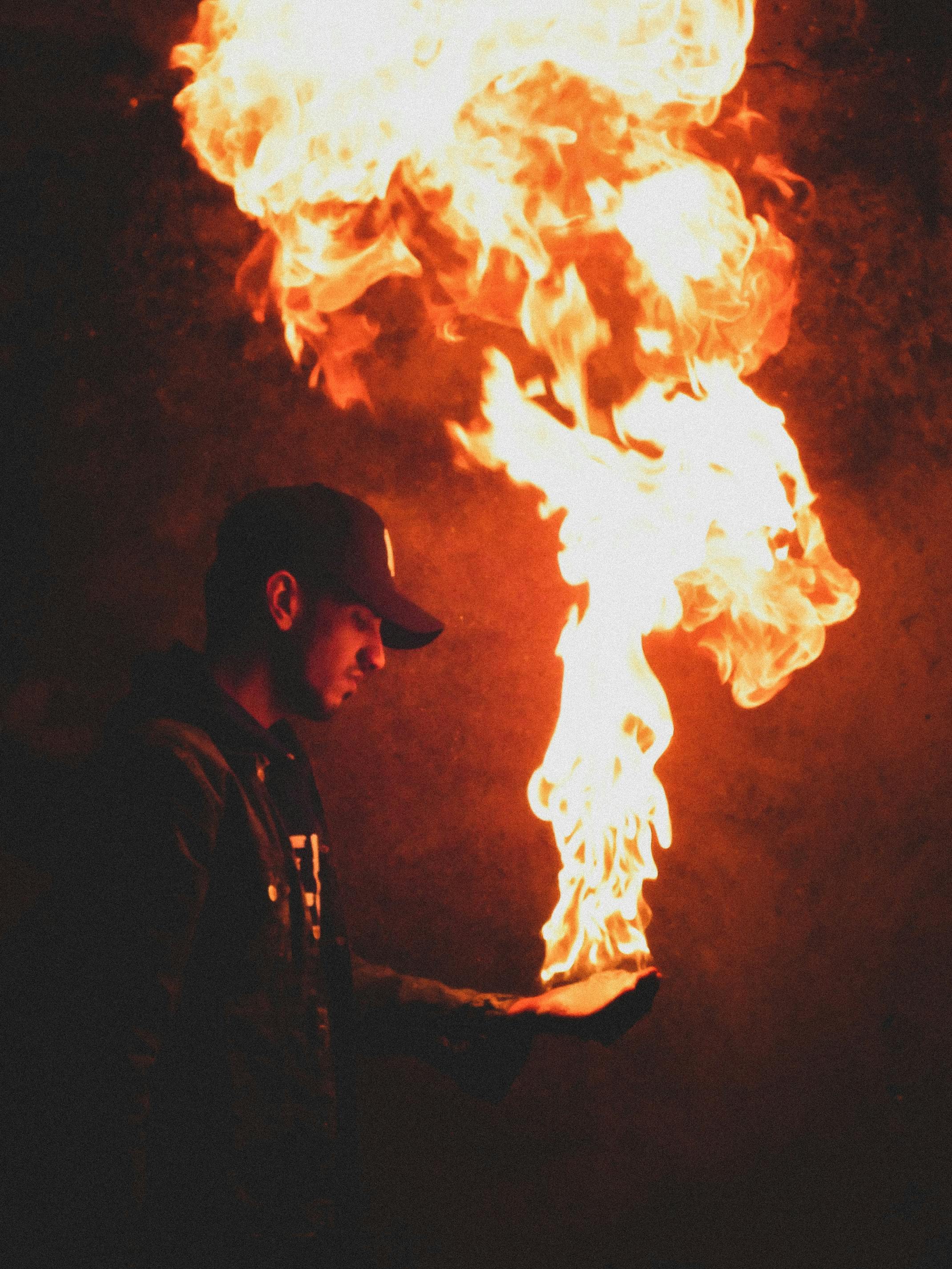 Dramatic Fire Performer in Low Light · Free Stock Photo