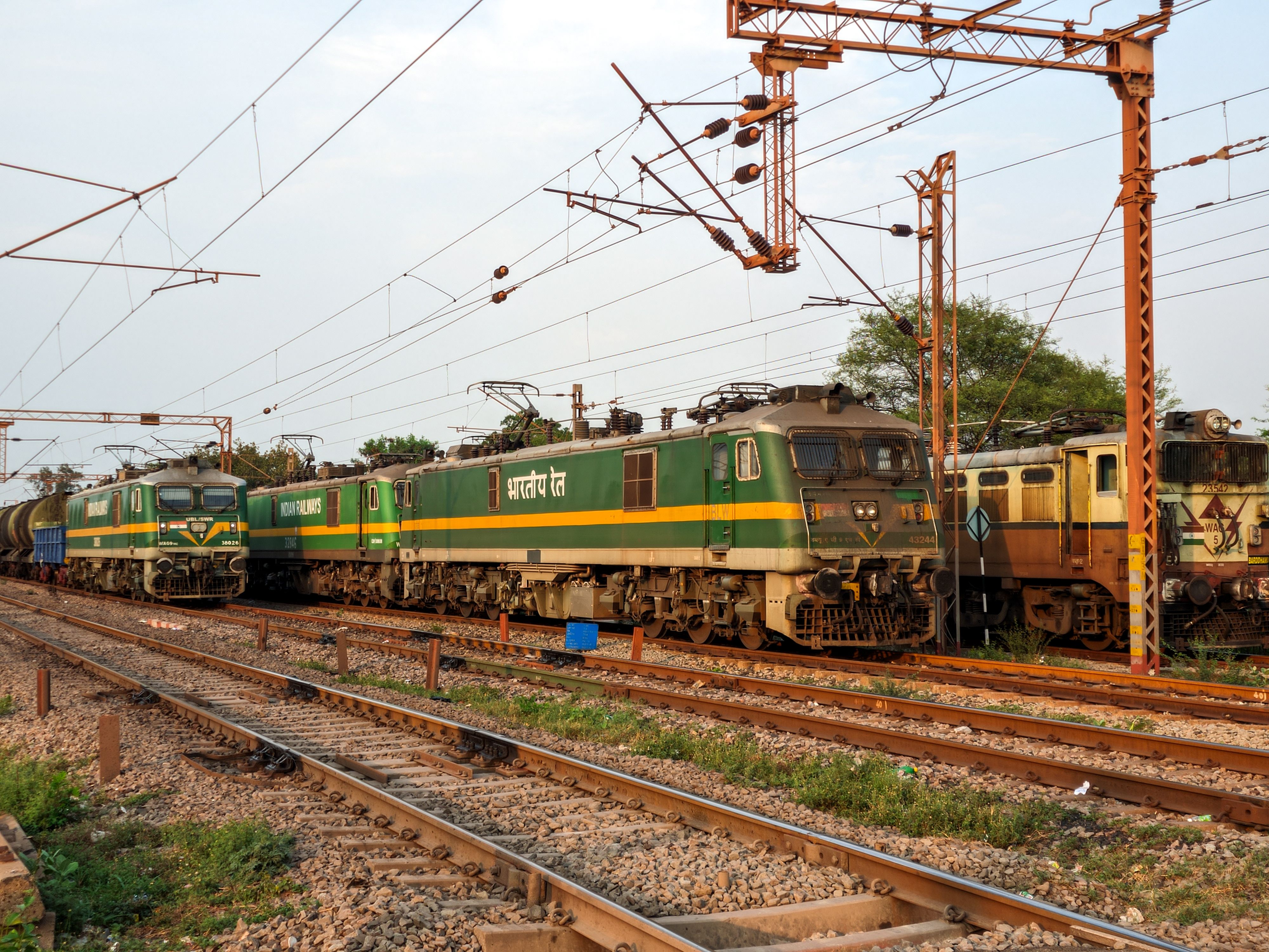 Green Indian Electric Locomotive on Railway Tracks · Free Stock Photo