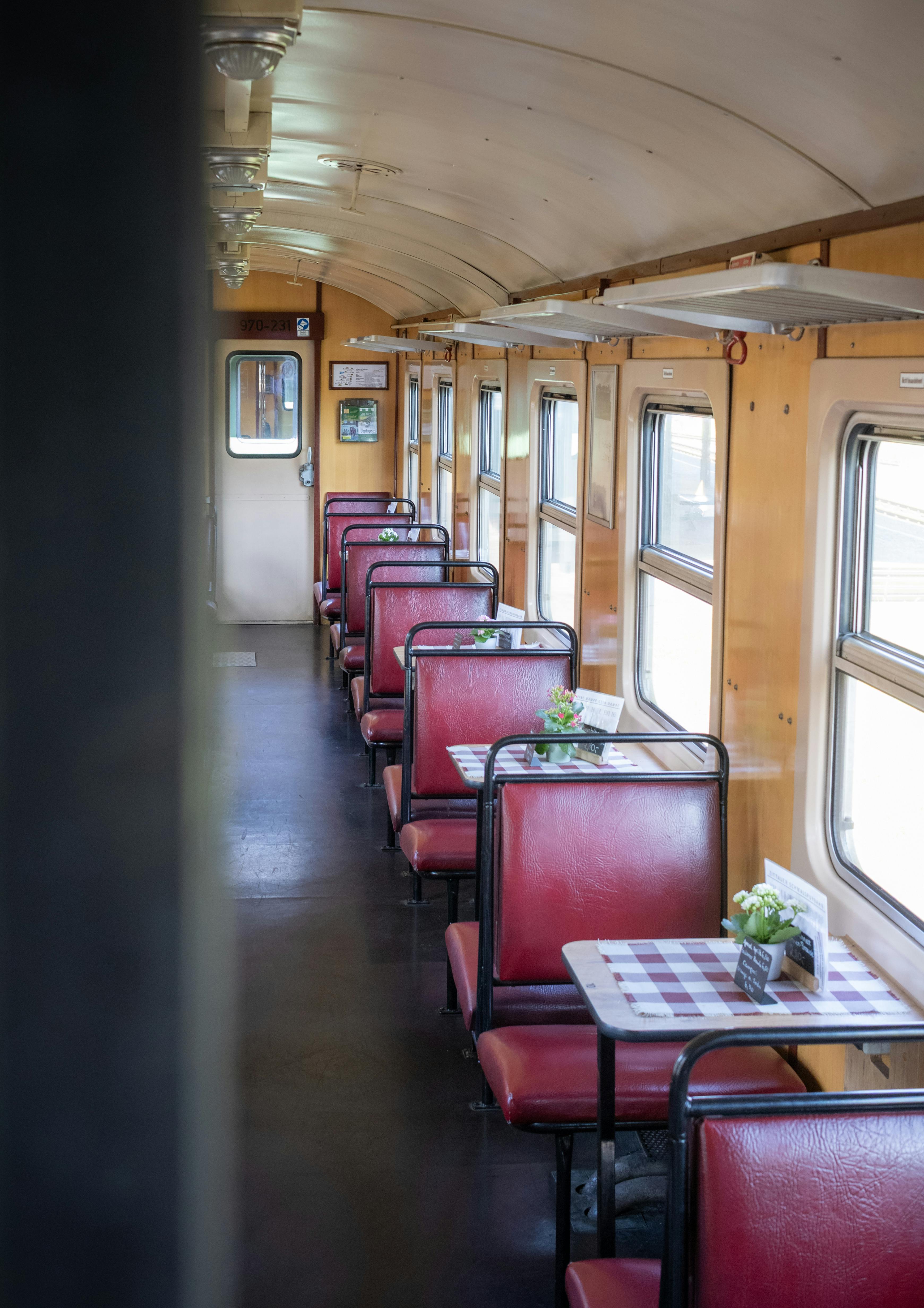 Vintage Train Dining Car with Checkerboard Tables · Free Stock Photo