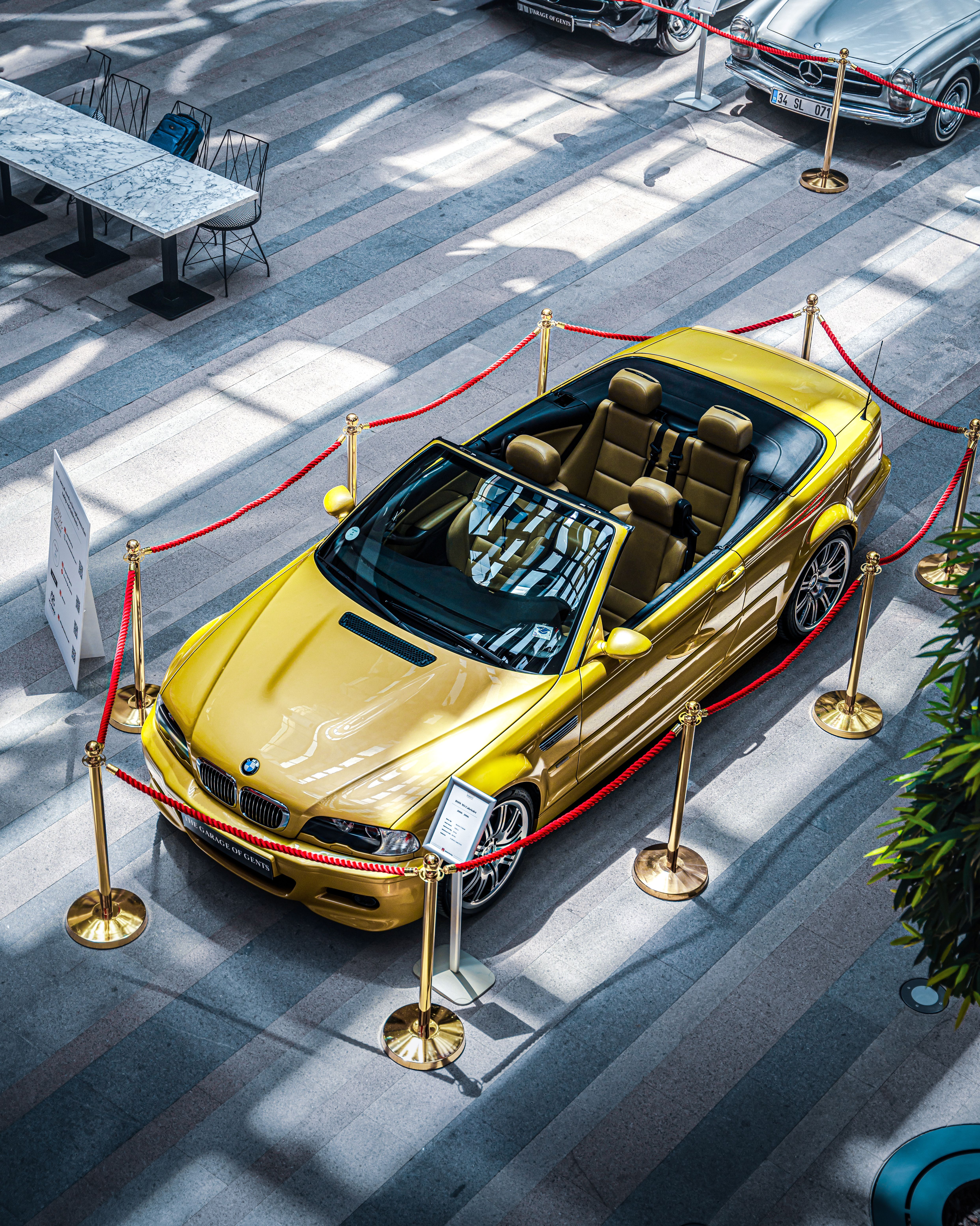 Luxurious Golden Convertible Displayed Indoors · Free Stock Photo