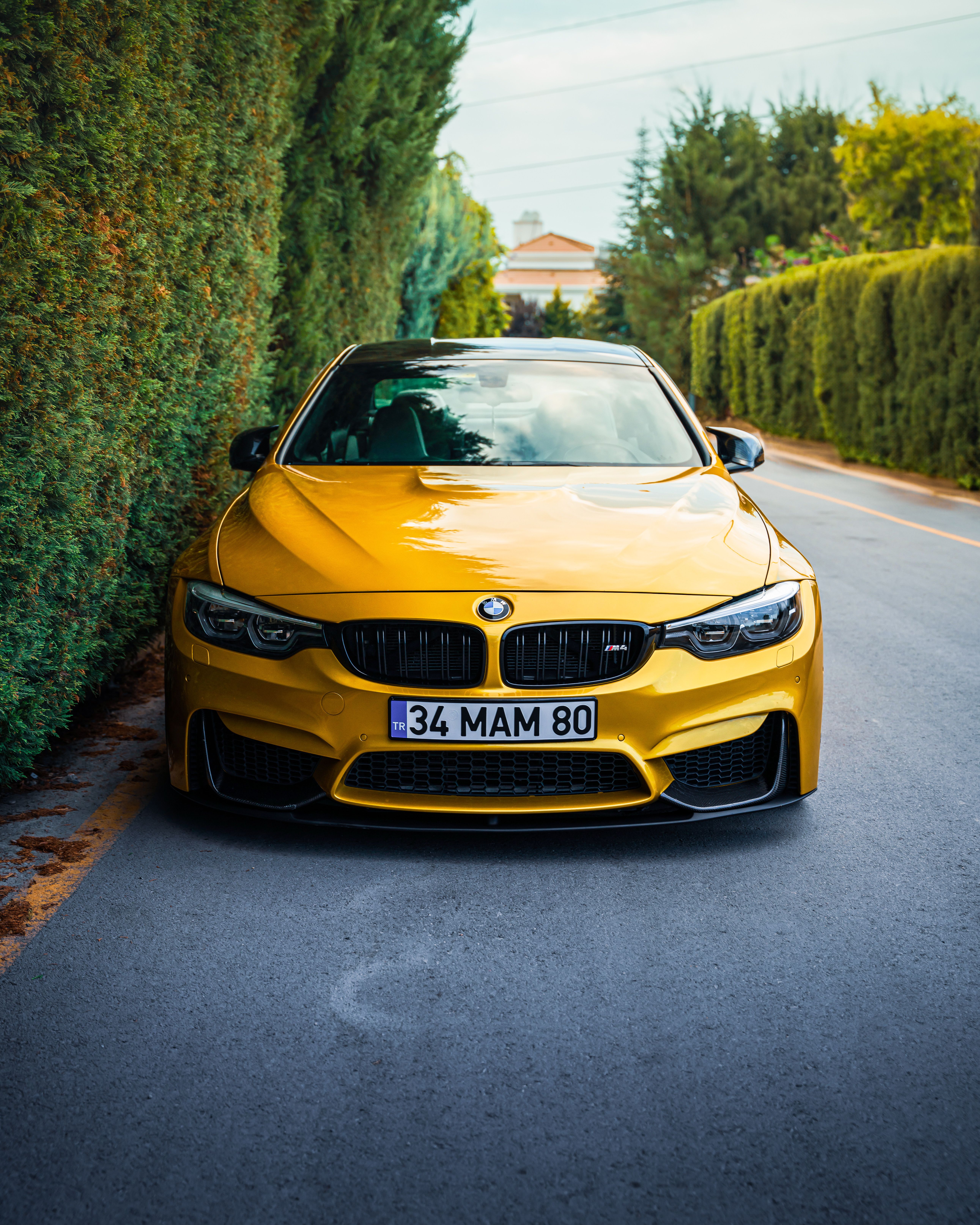 Vibrant Yellow Car Parked on Scenic Street · Free Stock Photo