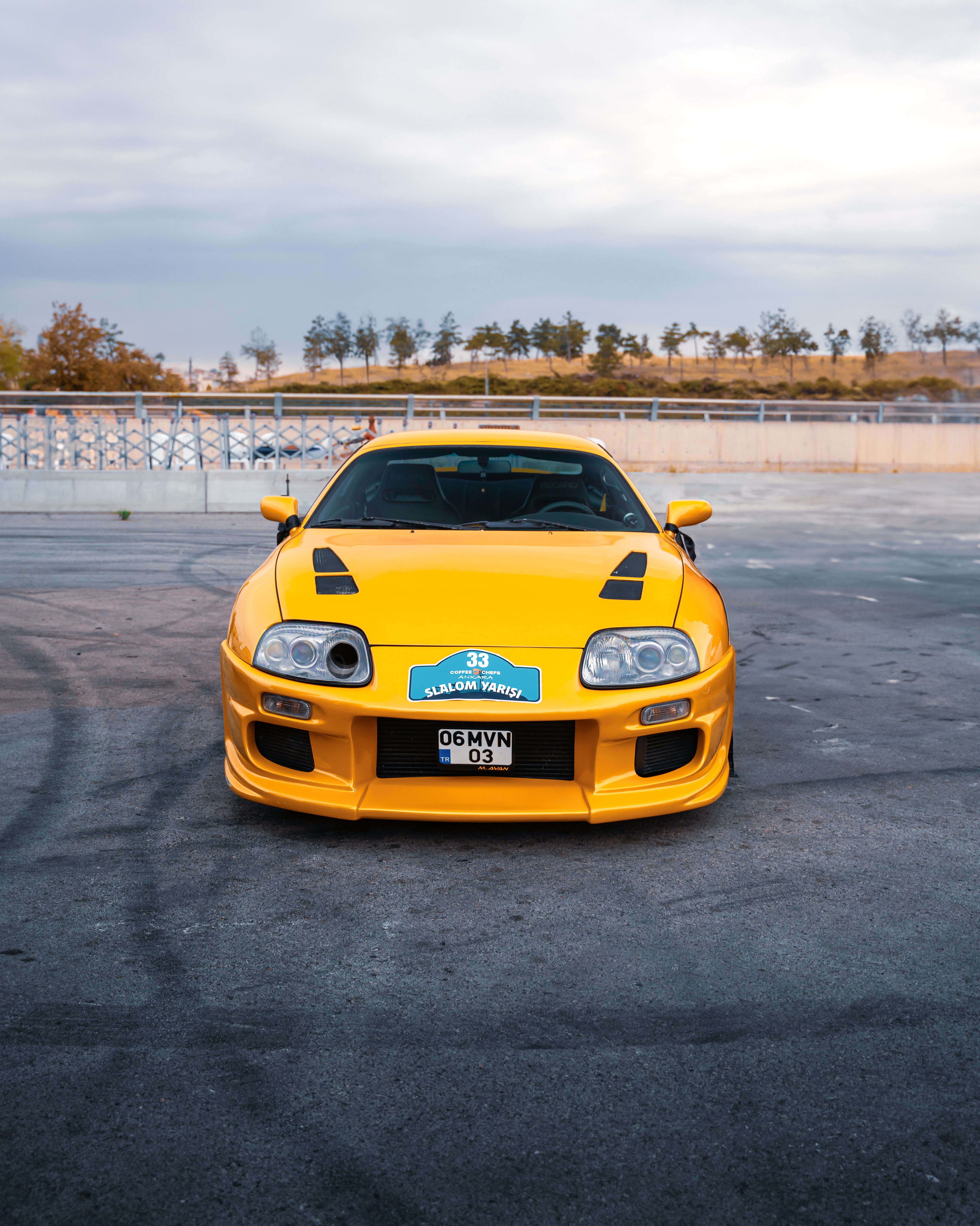 Yellow Toyota Supra on City Street at Sunset · Free Stock Photo