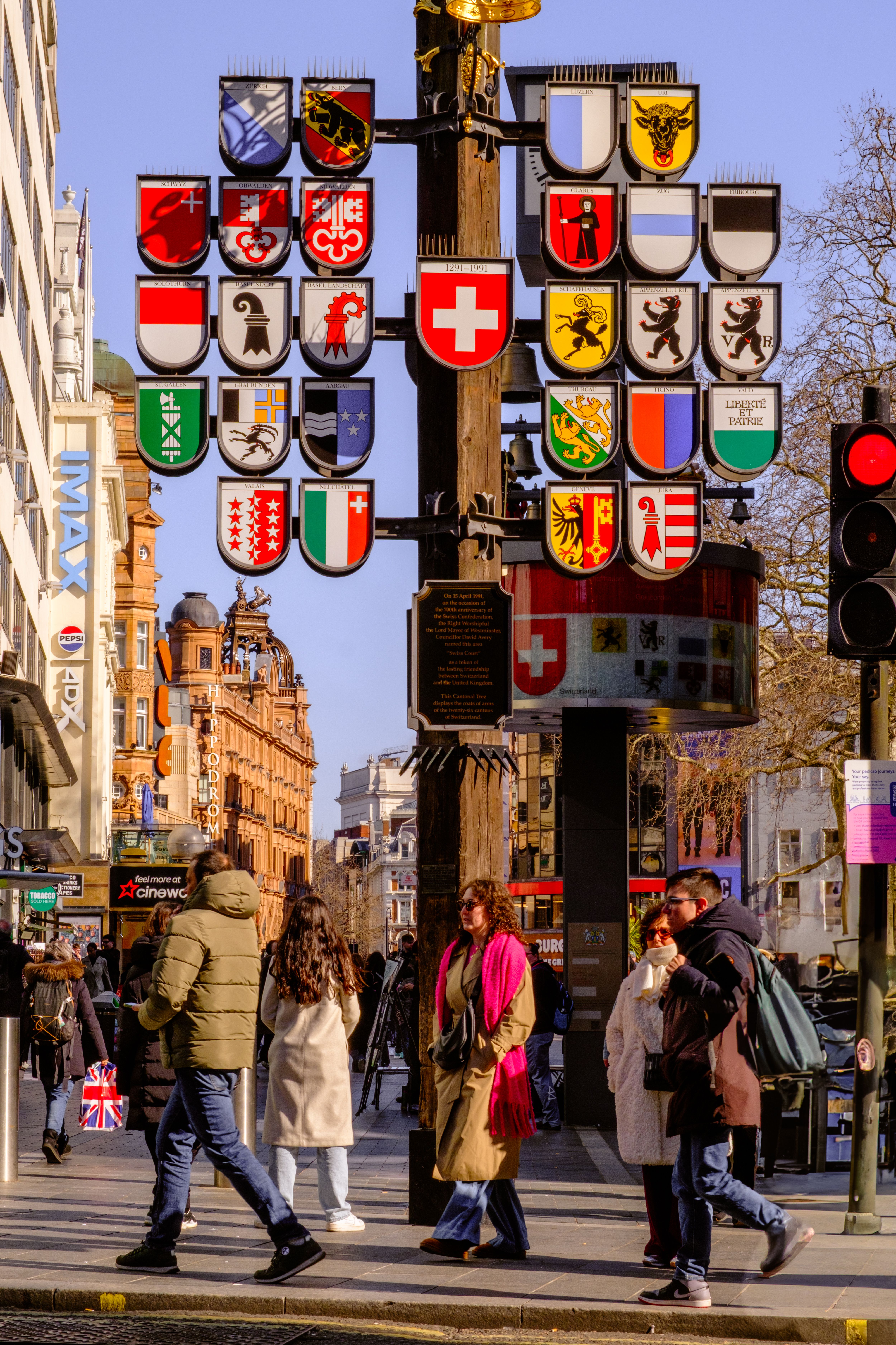 Busy London Street with Iconic Swiss Flags Display · Free Stock Photo