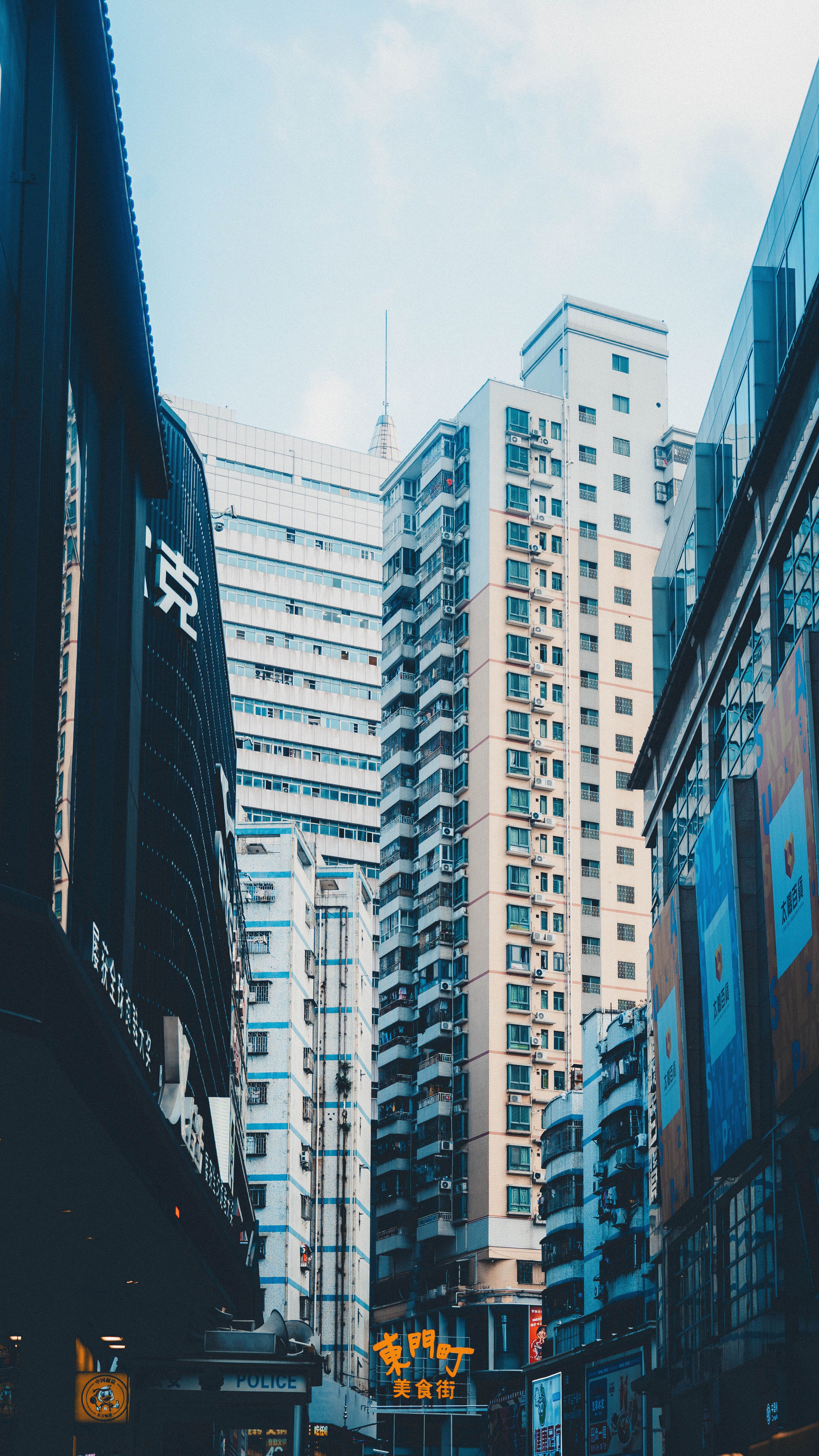 Urban Skyline with Tall Buildings Under Blue Sky · Free Stock Photo