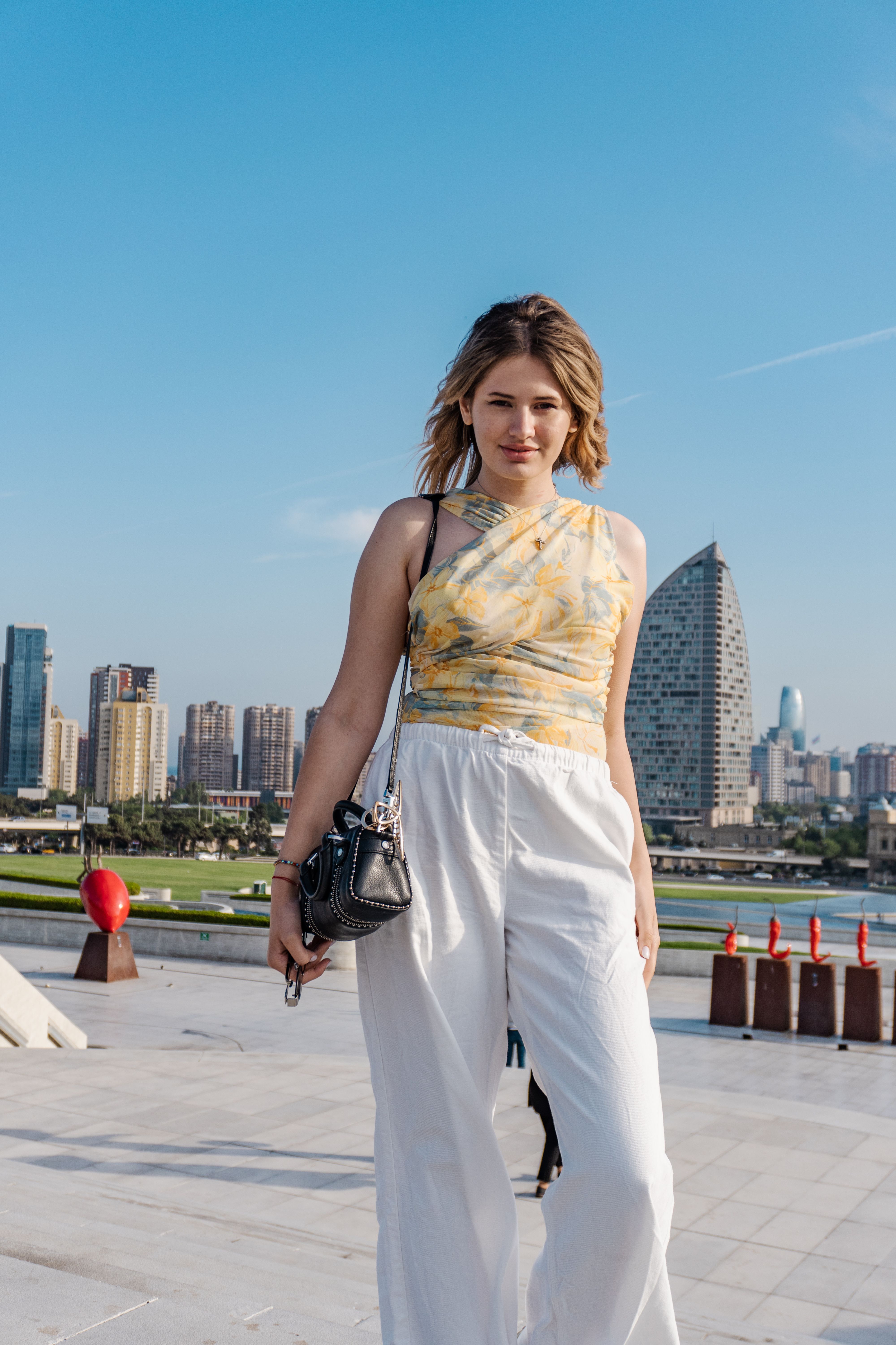 Woman in Stylish Outfit with Urban Skyline · Free Stock Photo