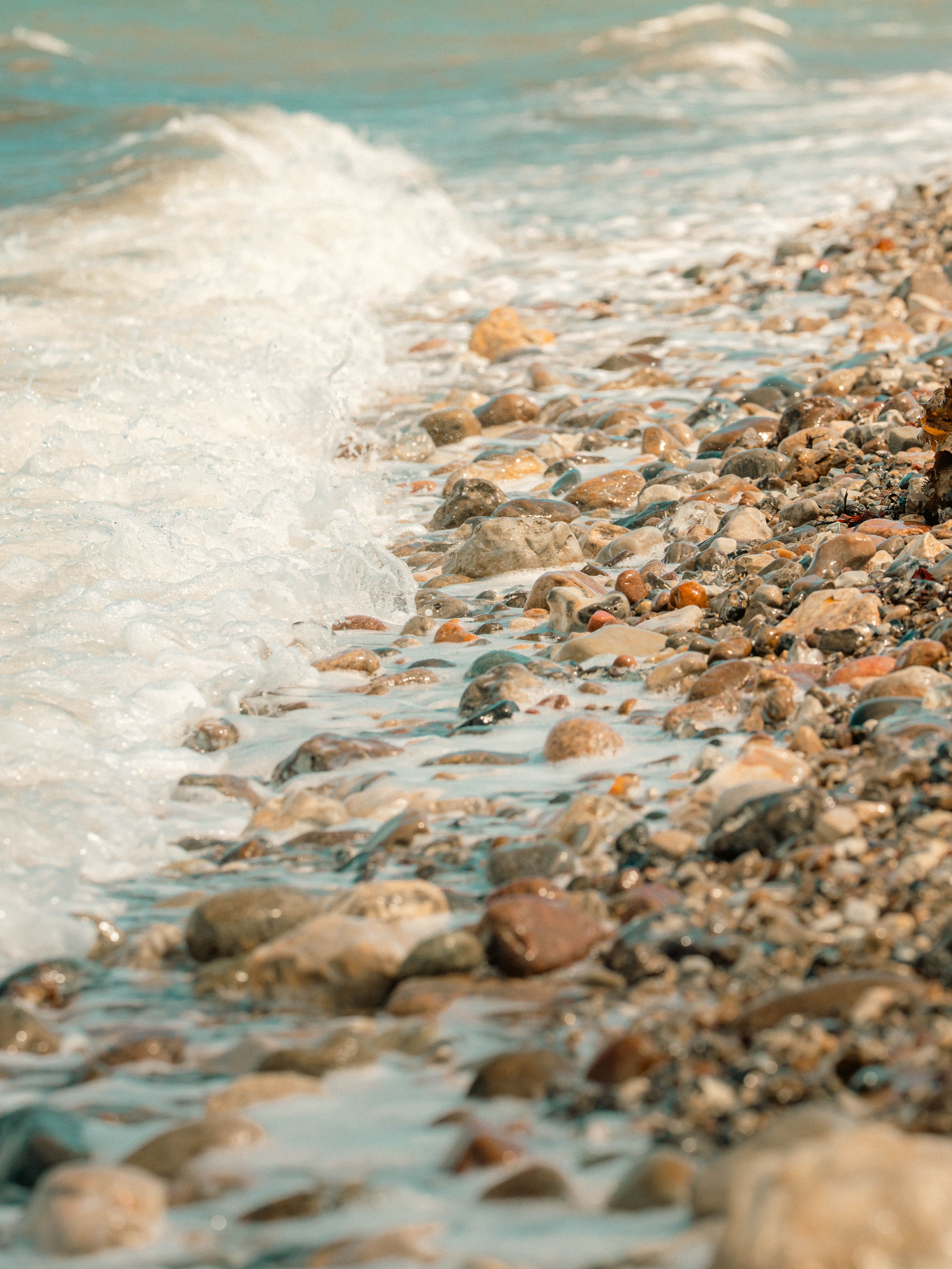 Scenic Rocky Beach Shoreline with Soft Waves · Free Stock Photo
