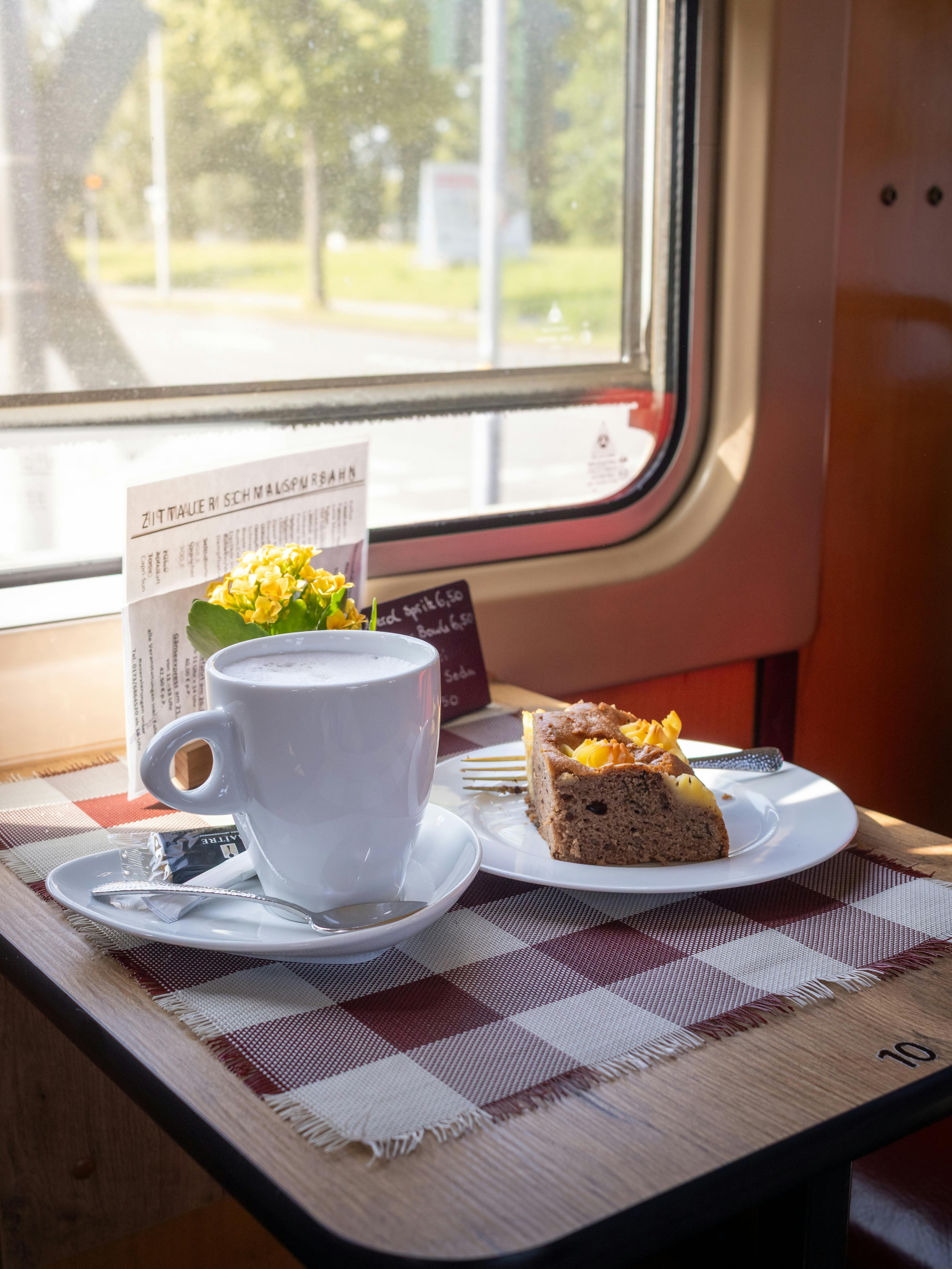 Cozy Train Ride with Coffee and Cake · Free Stock Photo