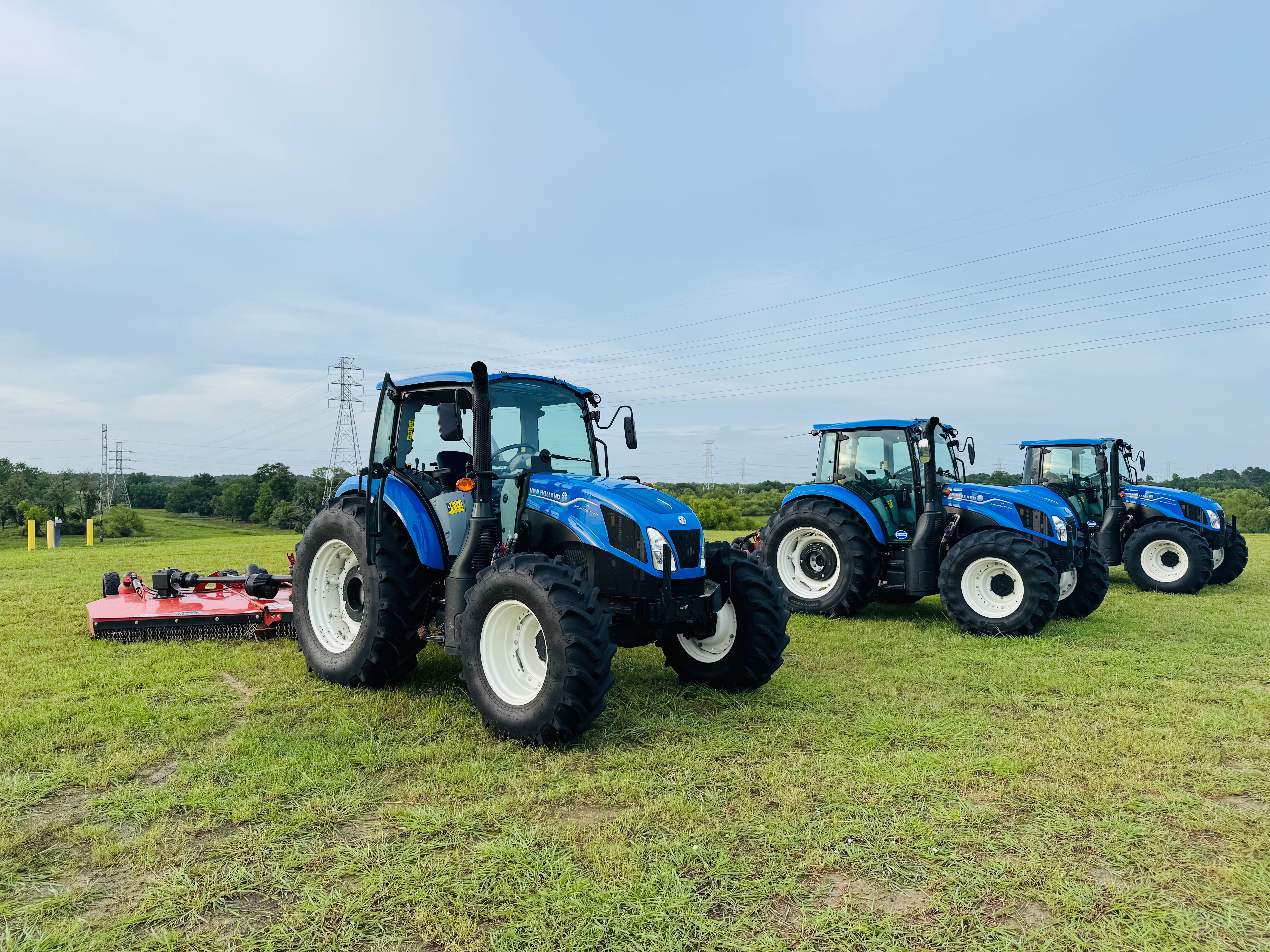 Blue Tractors in Houston Field on Clear Day · Free Stock Photo