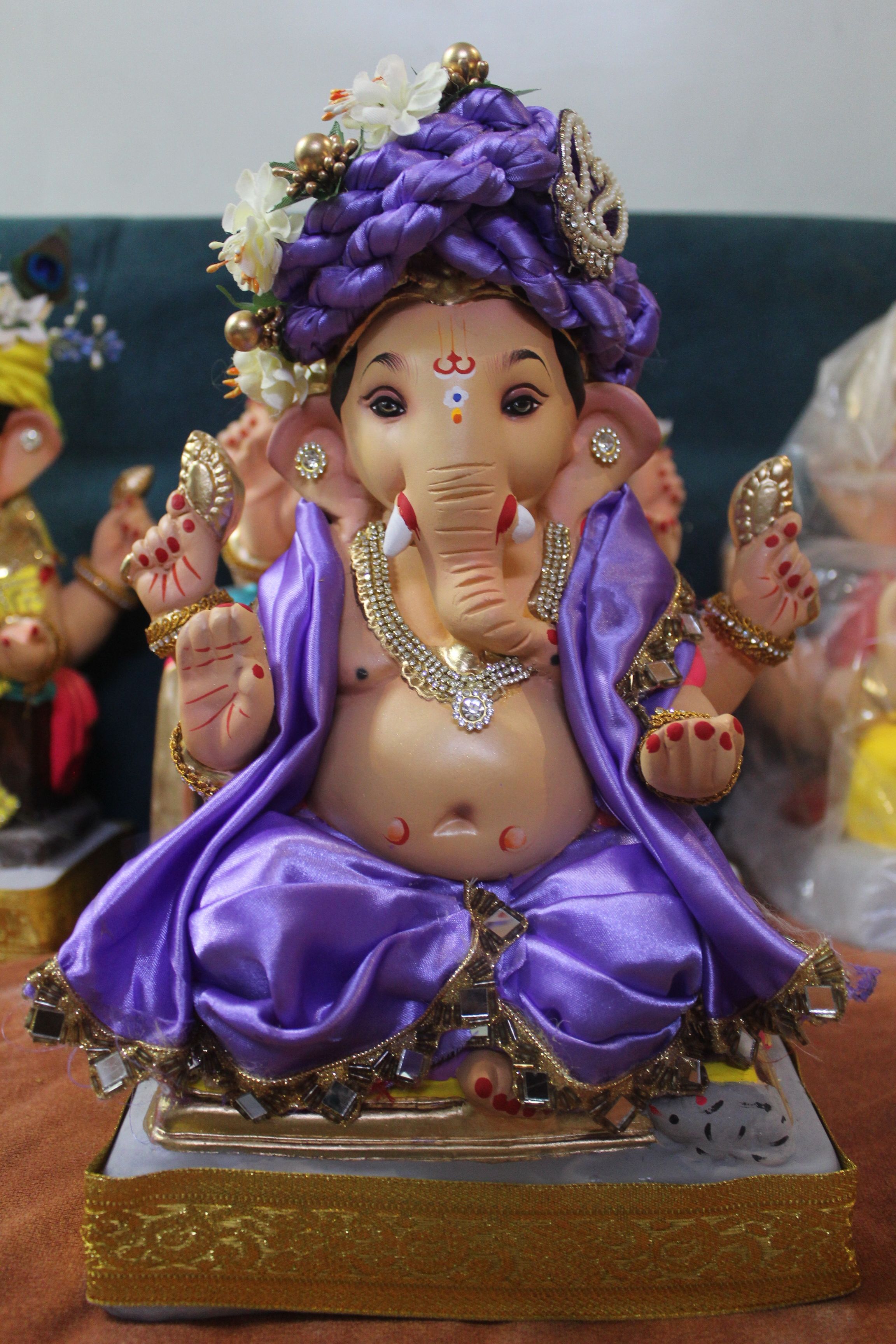 Vibrant Lord Ganesha Idol with Purple Attire · Free Stock Photo
