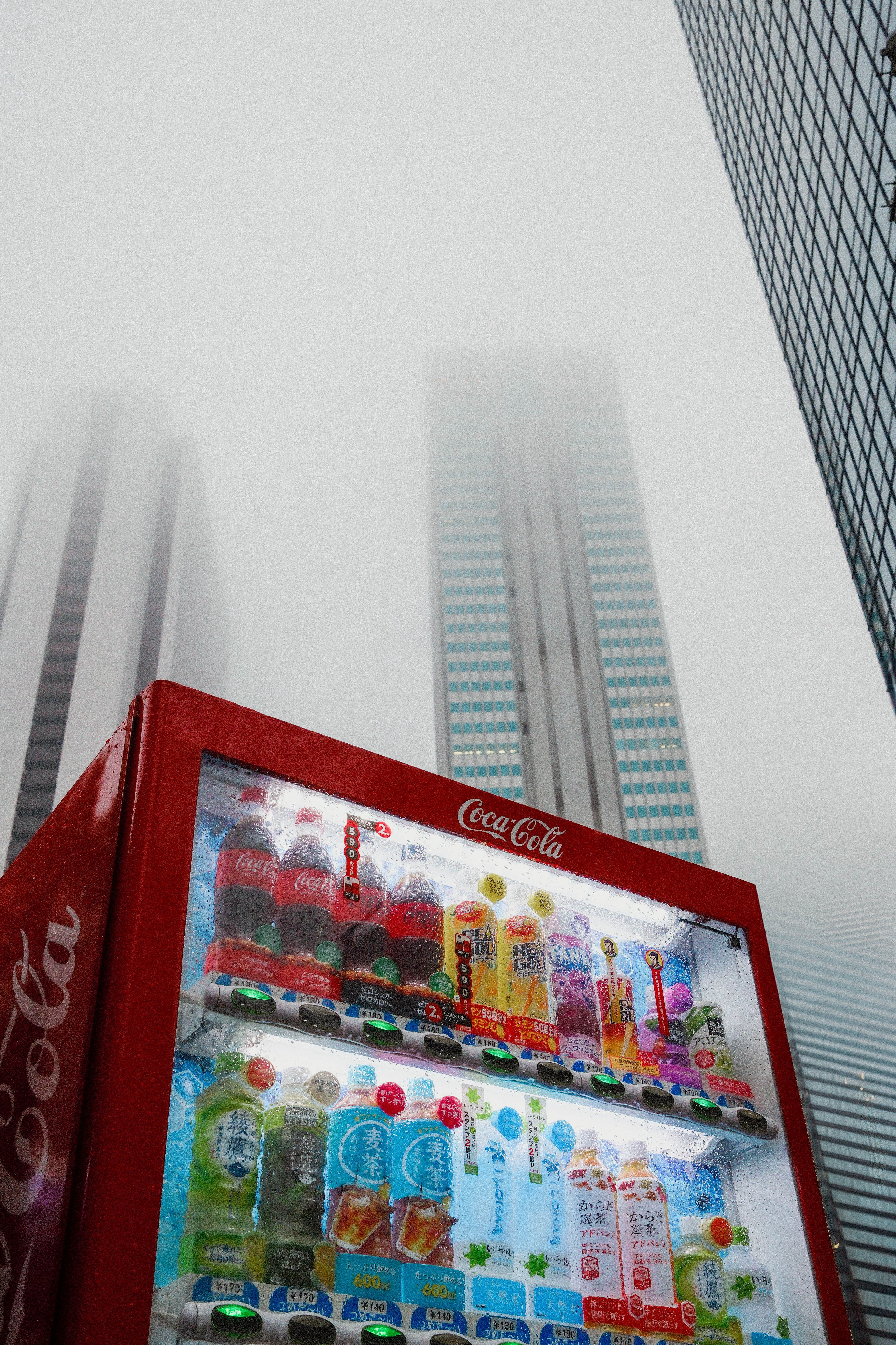 Coca-Cola Vending Machine in Foggy Tokyo Skyscrapers · Free Stock Photo