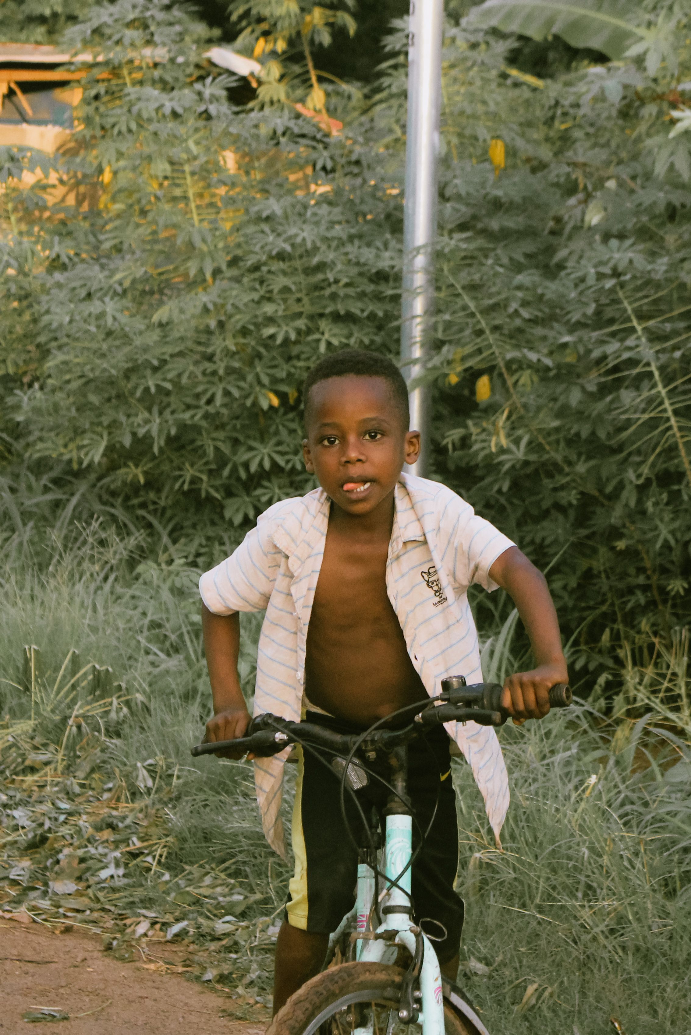 Young African Boy Riding Bicycle in Nigeria · Free Stock Photo